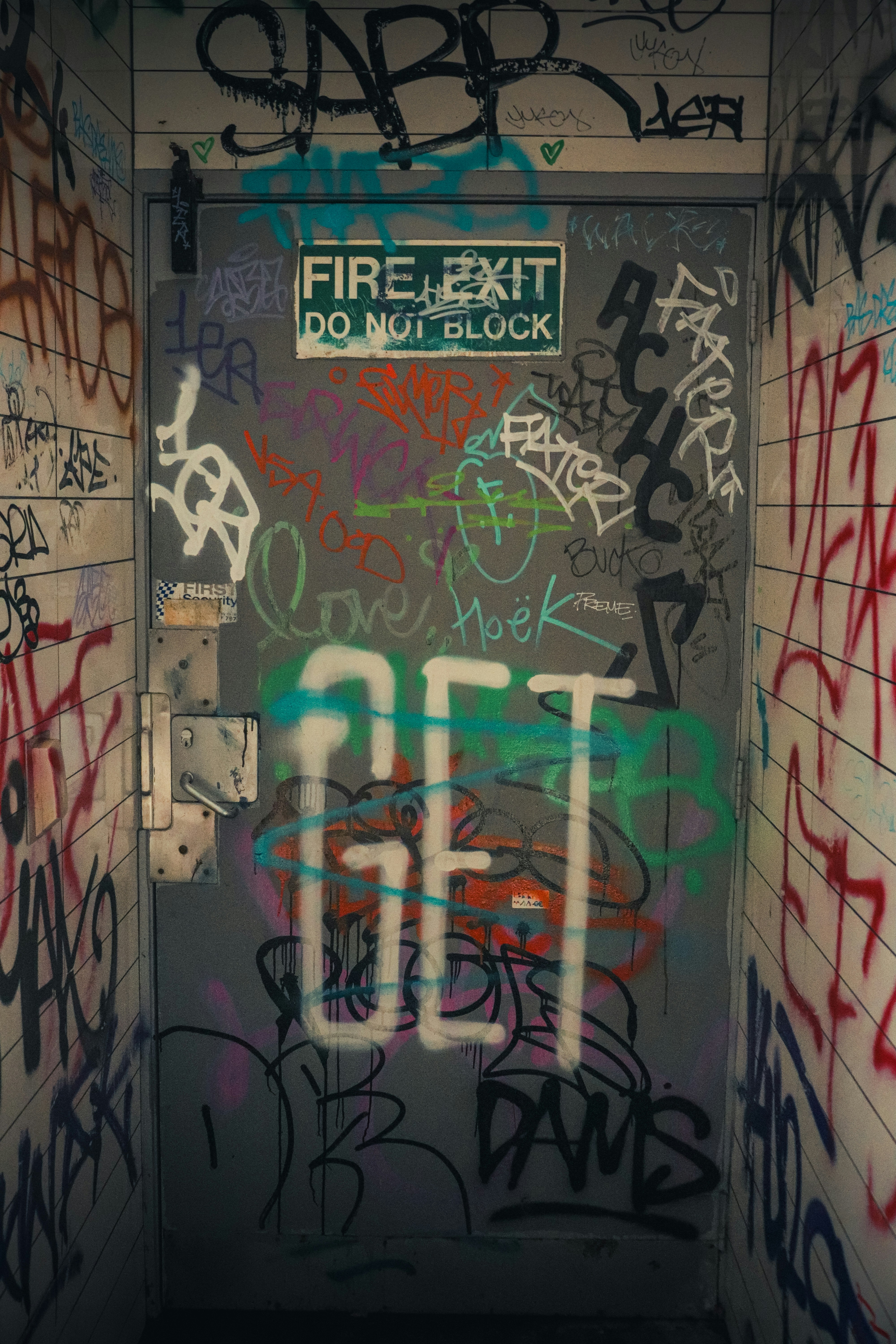 Graffiti Gate: A Fire Exit Door Dressed in Colorful Street Art