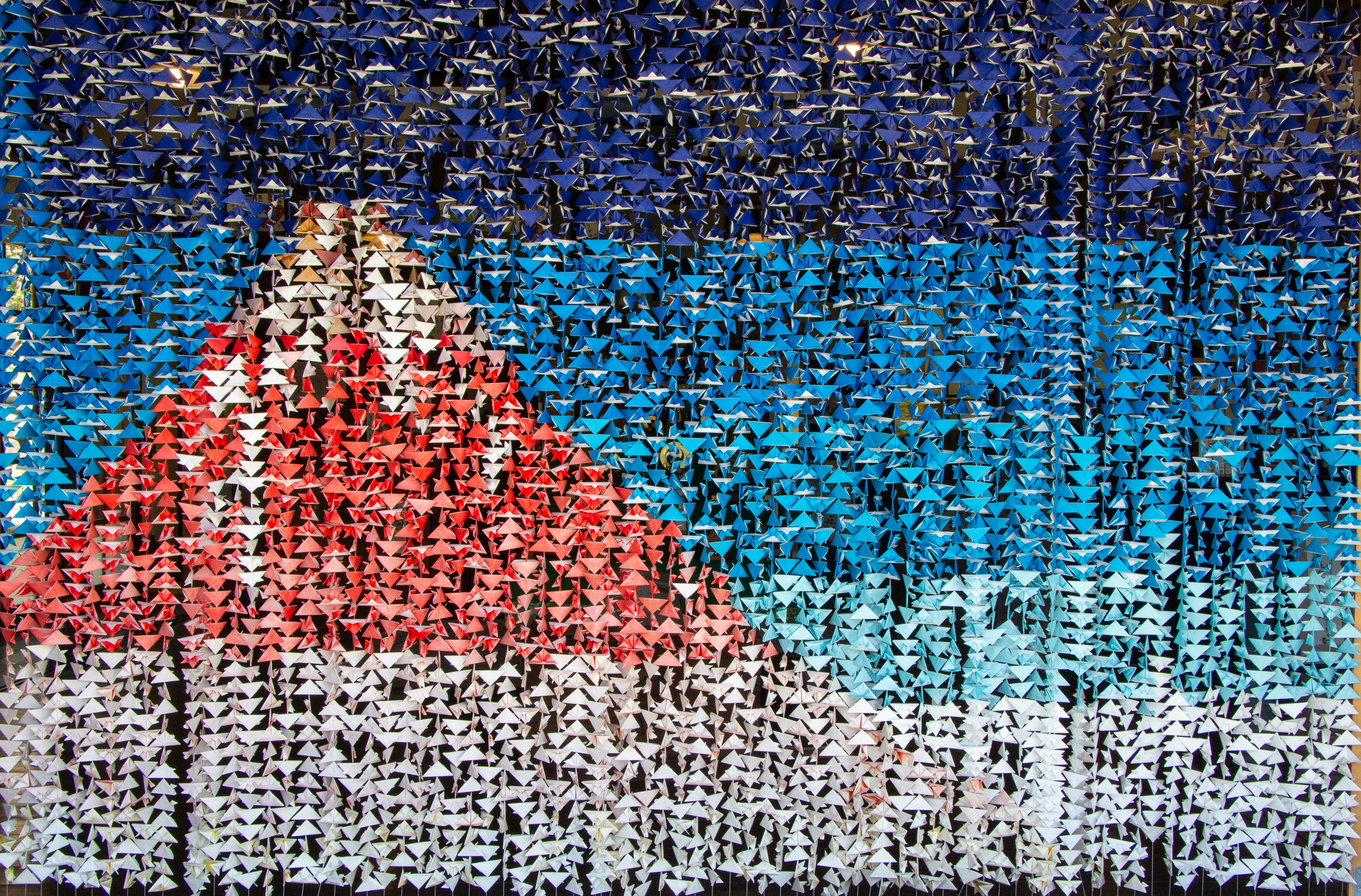 Crimson Summit Adrift in a Mosaic Sea of Blue Triangles
