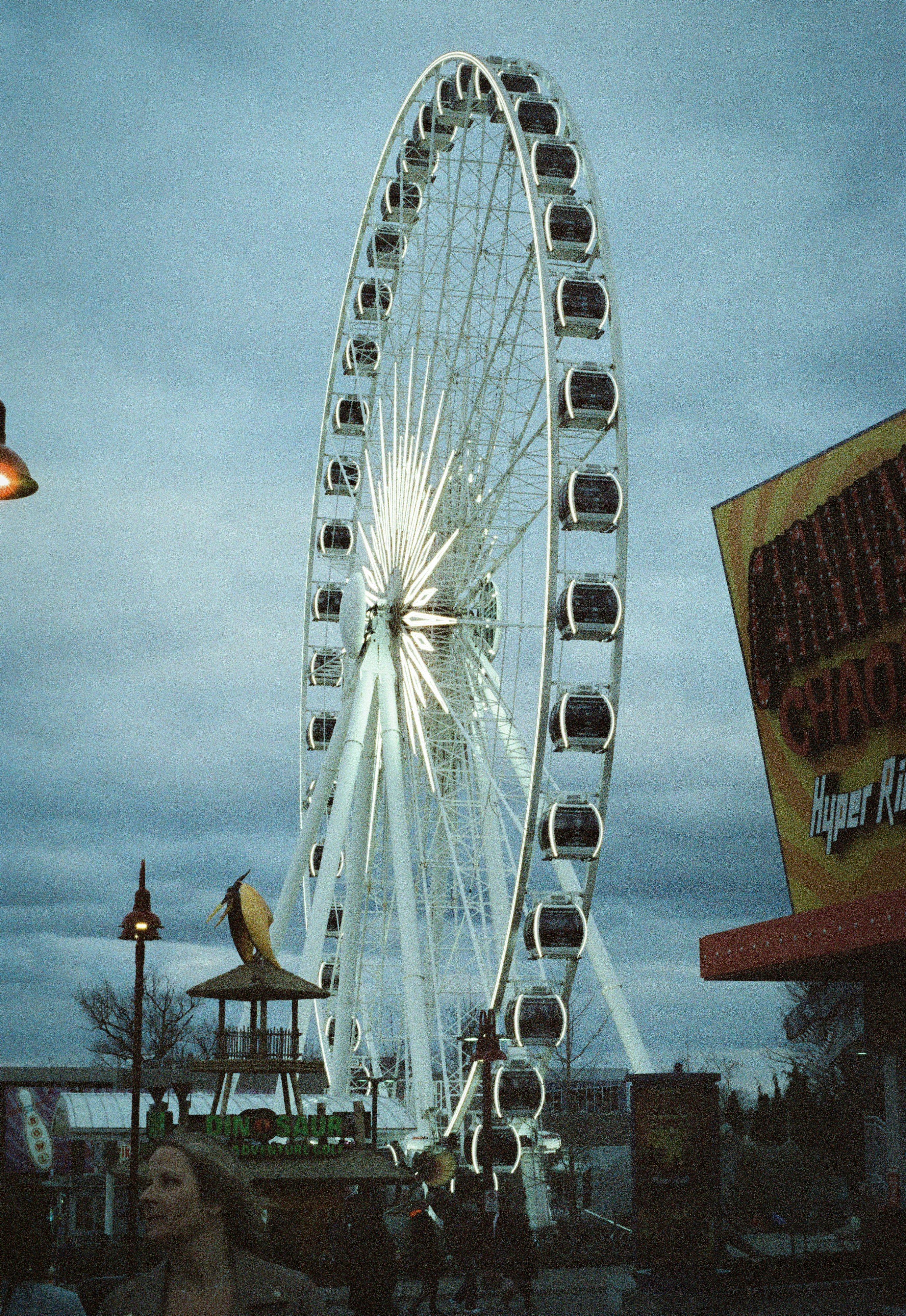 A large ferris wheel sitting next to a tall building photo – Free ...