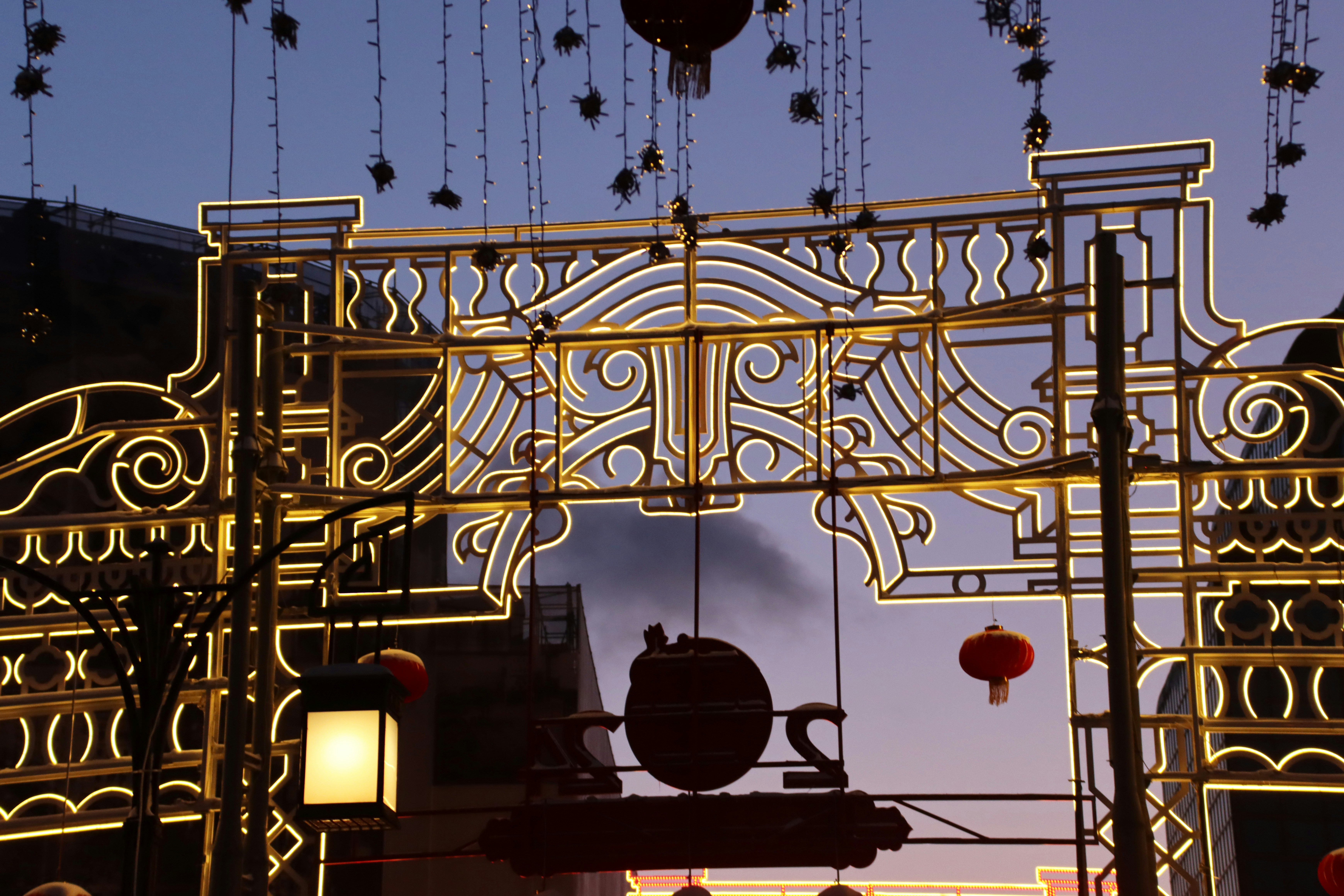 A large metal gate with lanterns hanging from it's sides photo – Free ...