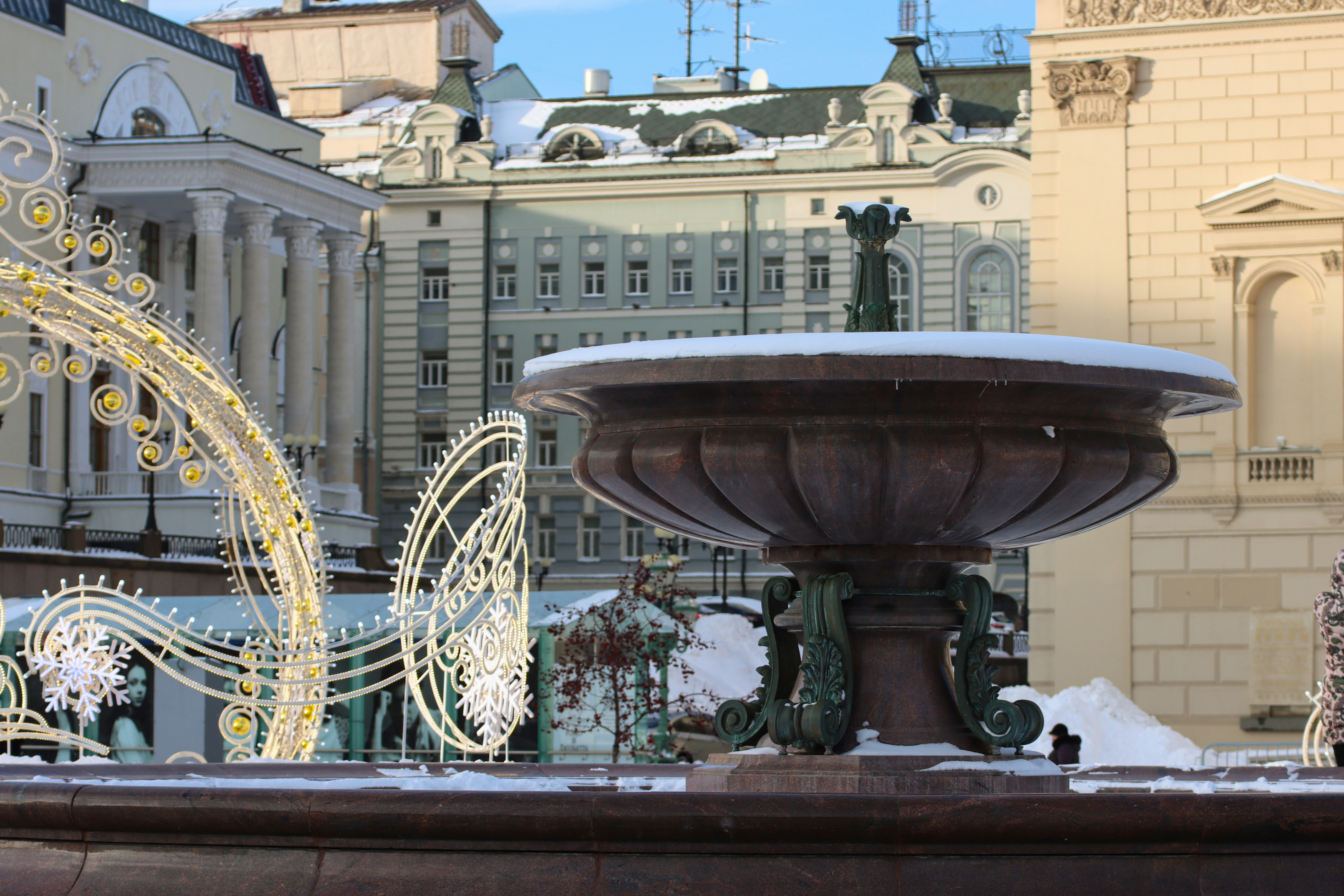 Snow-Capped Basin Framed by Ornate Lights in a Frosted City Square