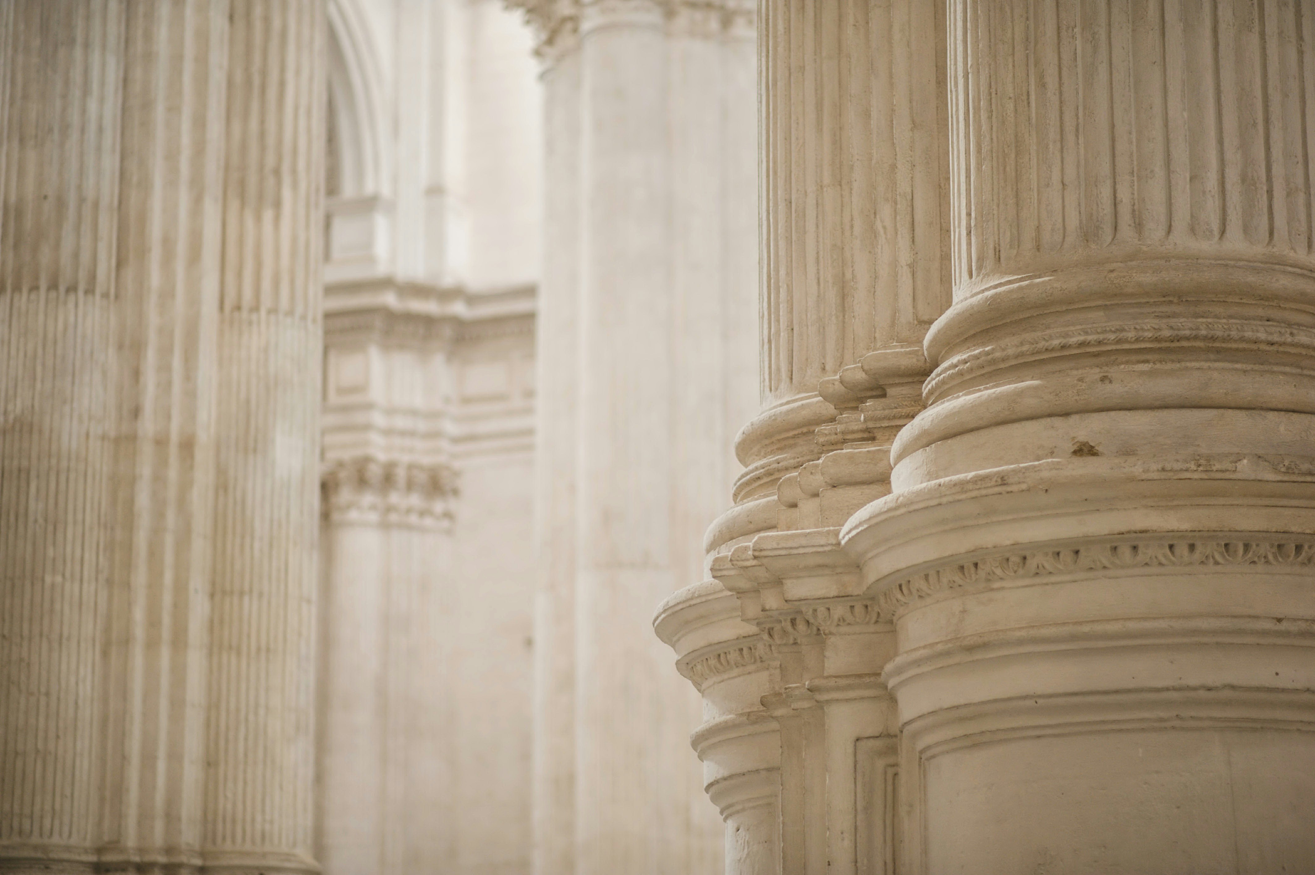 A close up of a pillar with a building in the background photo – Free ...