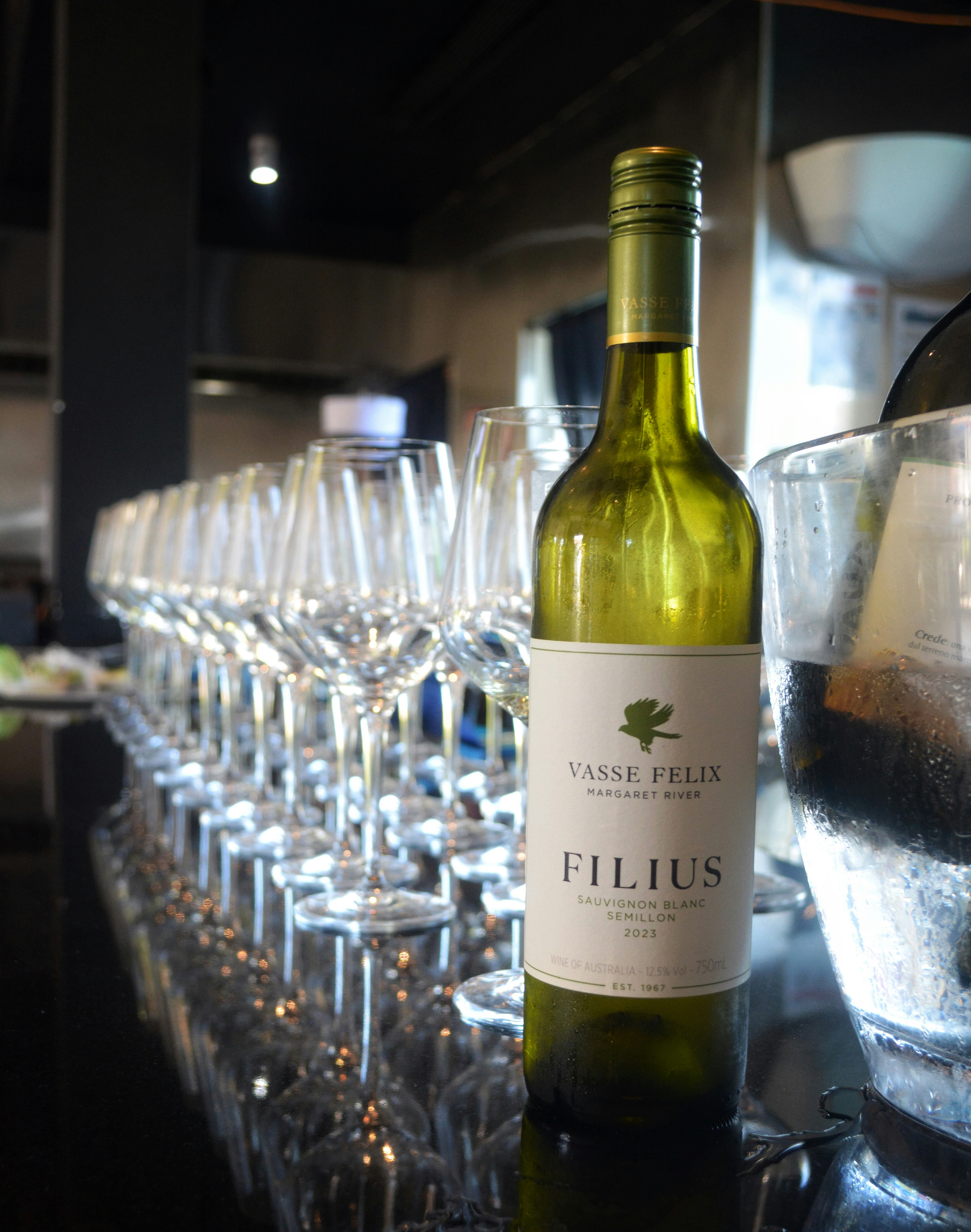 Vasse Felix Filius Framed by a Row of Glasses on a Reflective Bar