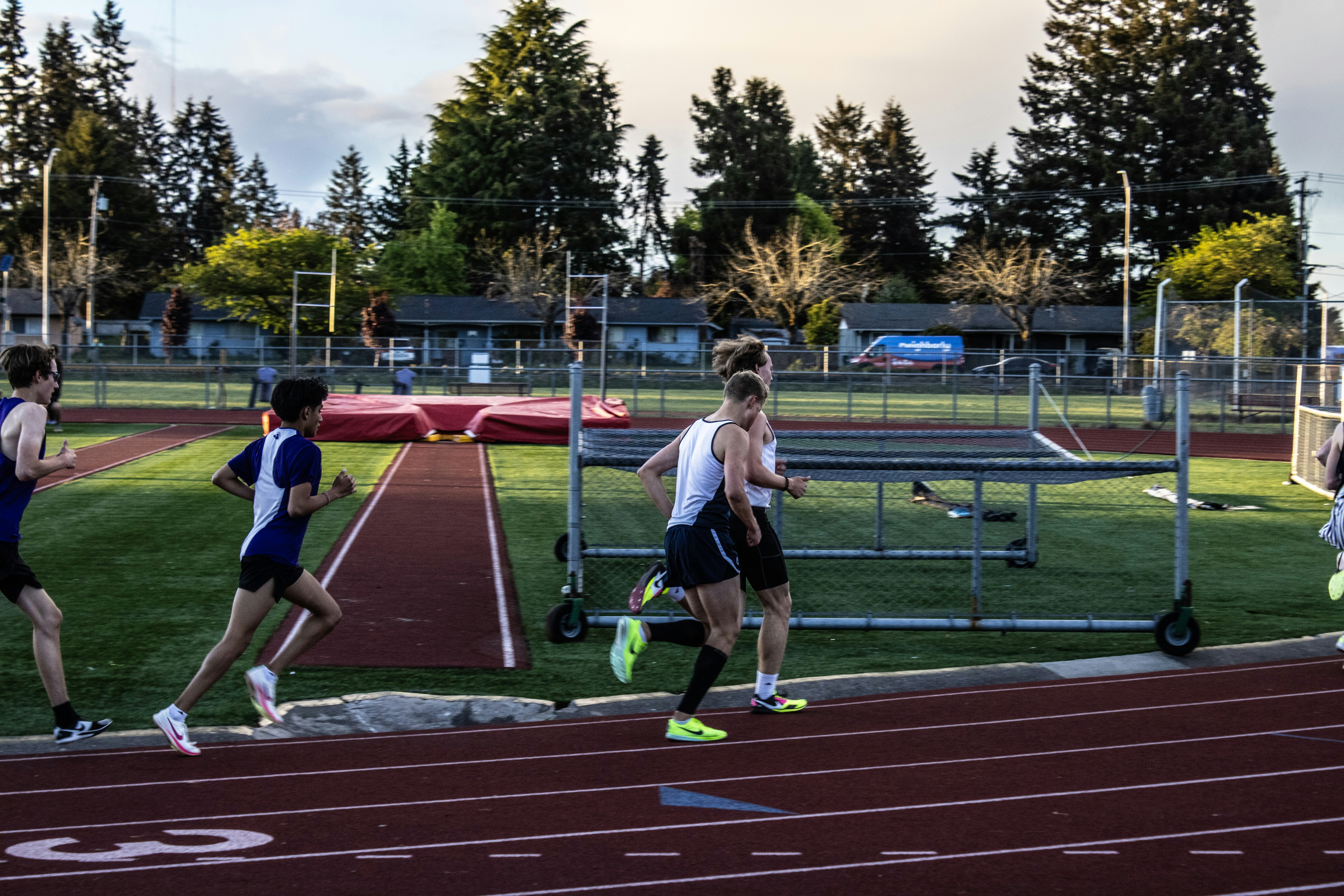 A group of people running on a track photo – Free Olympia Image on Unsplash