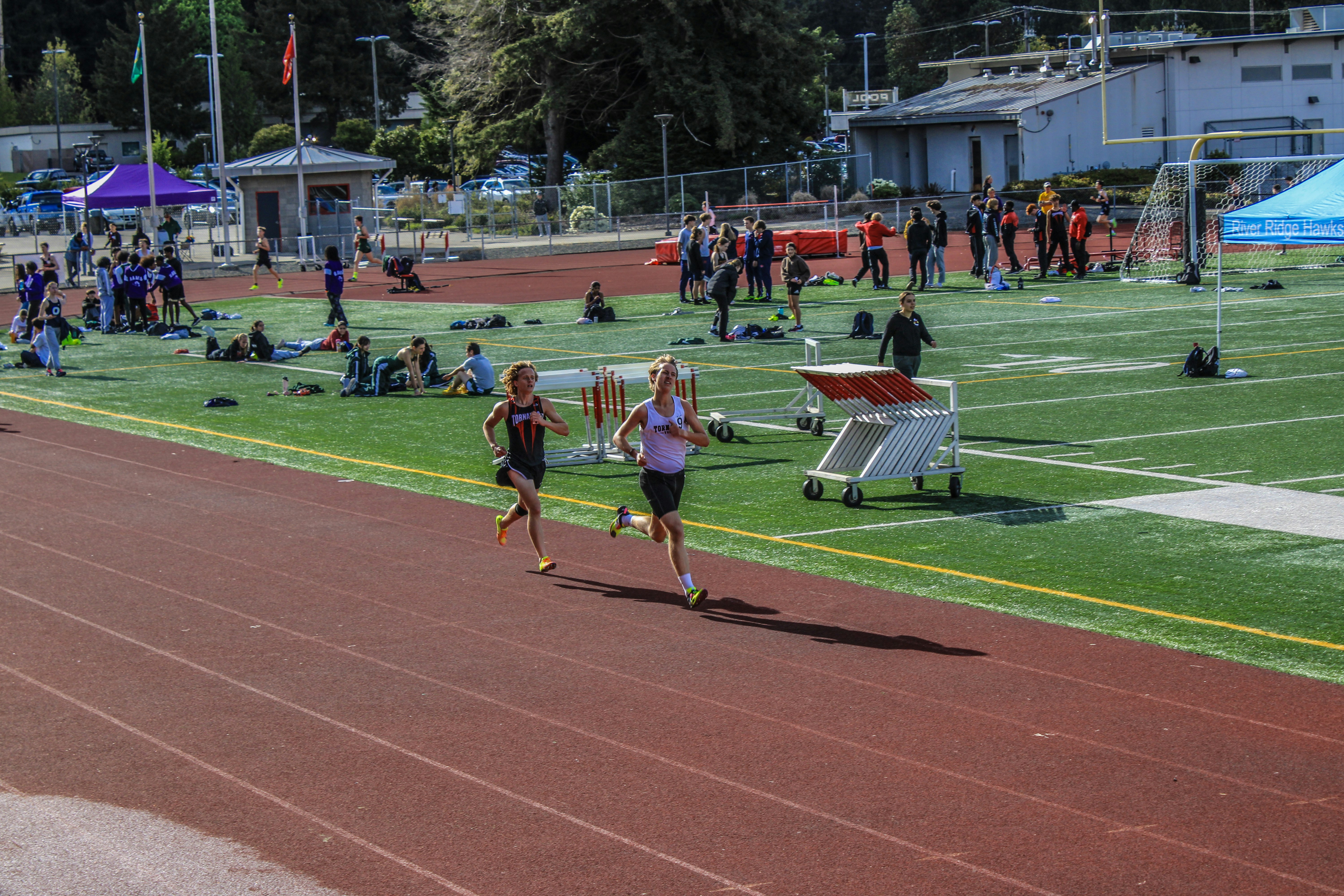 A couple of people that are running on a track photo – Free Olympia ...