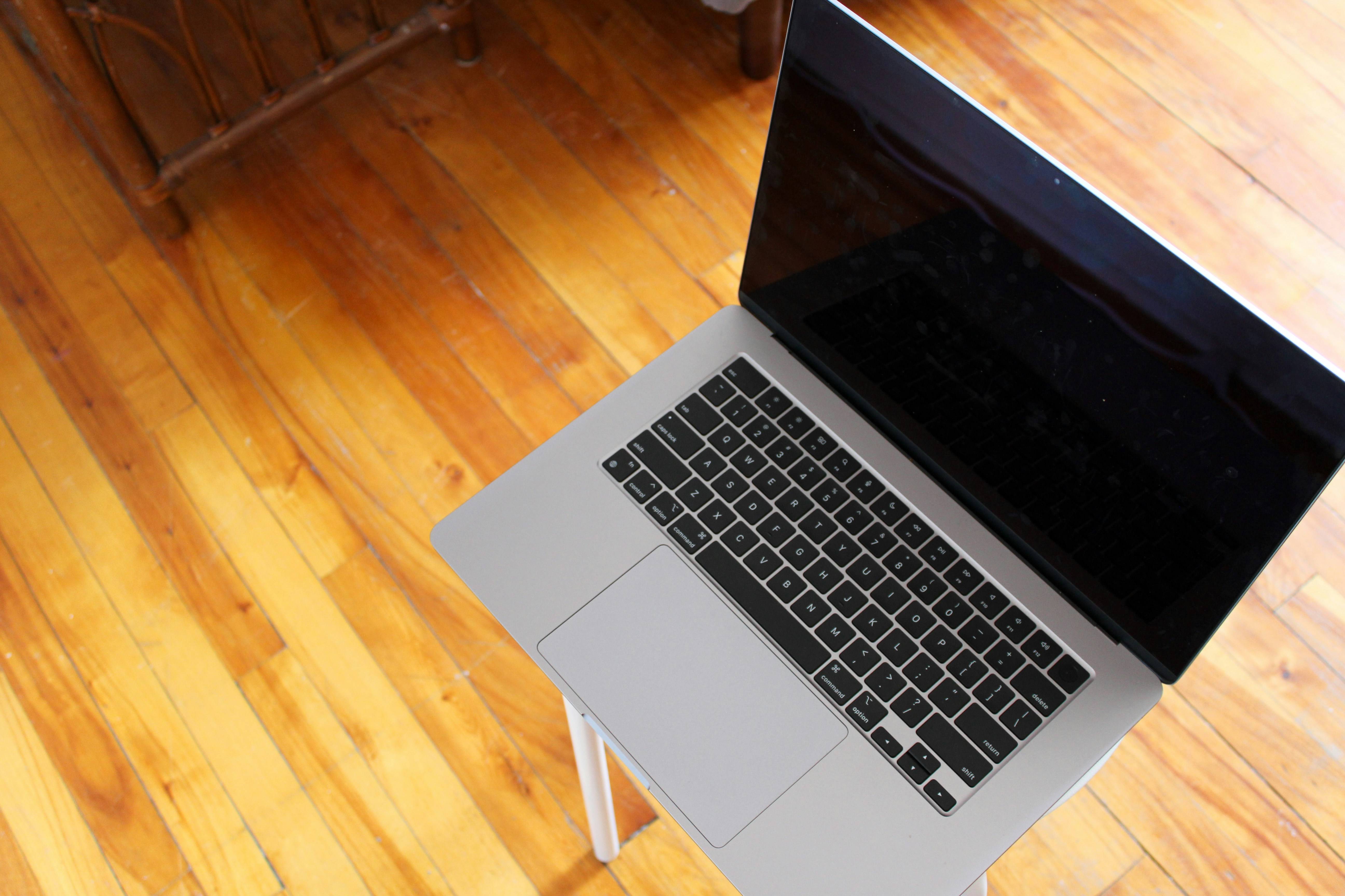 A laptop computer sitting on top of a wooden table photo – Free ...
