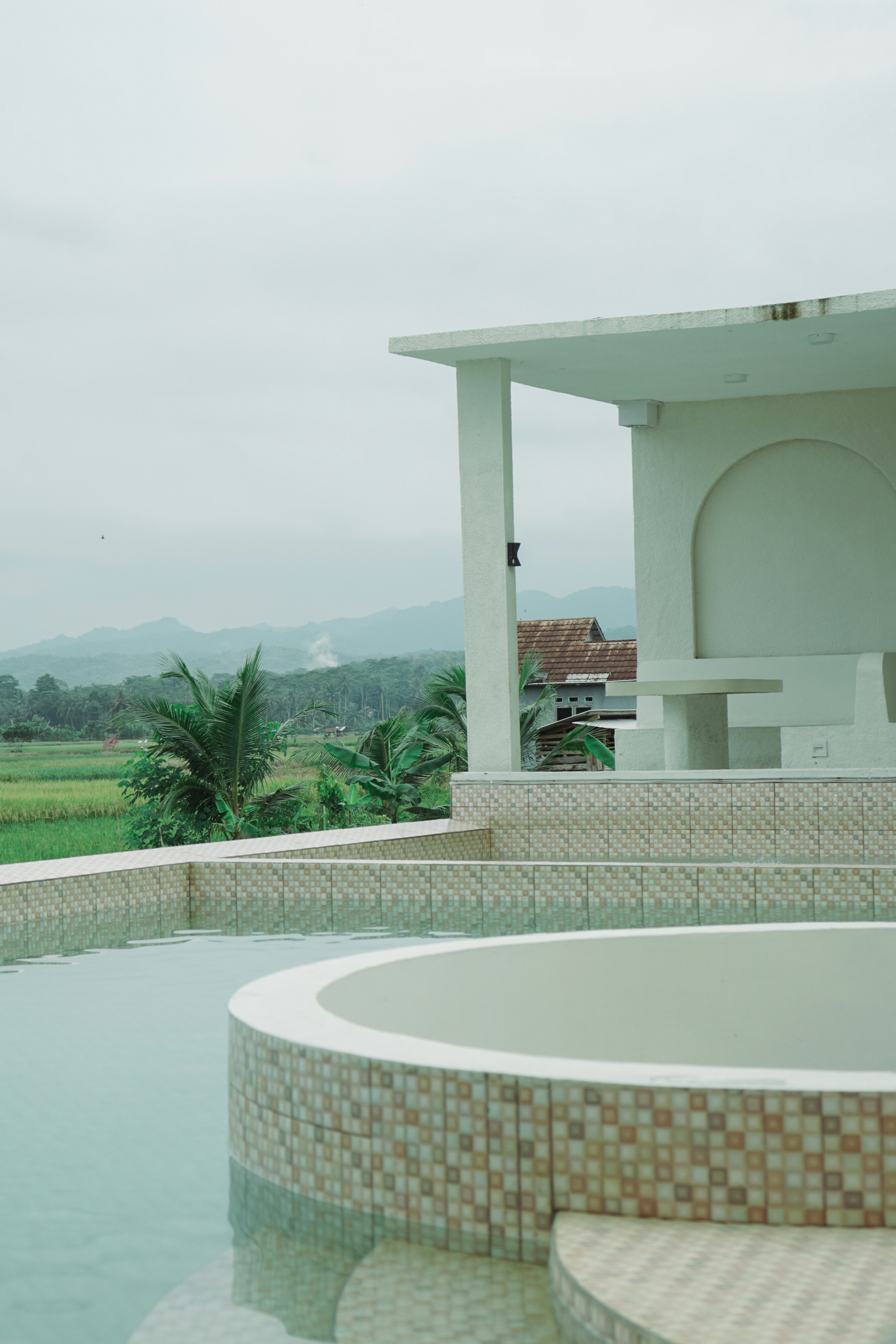 Geometry in White: A Modern Pavilion Framing a Serene Mosaic Pool