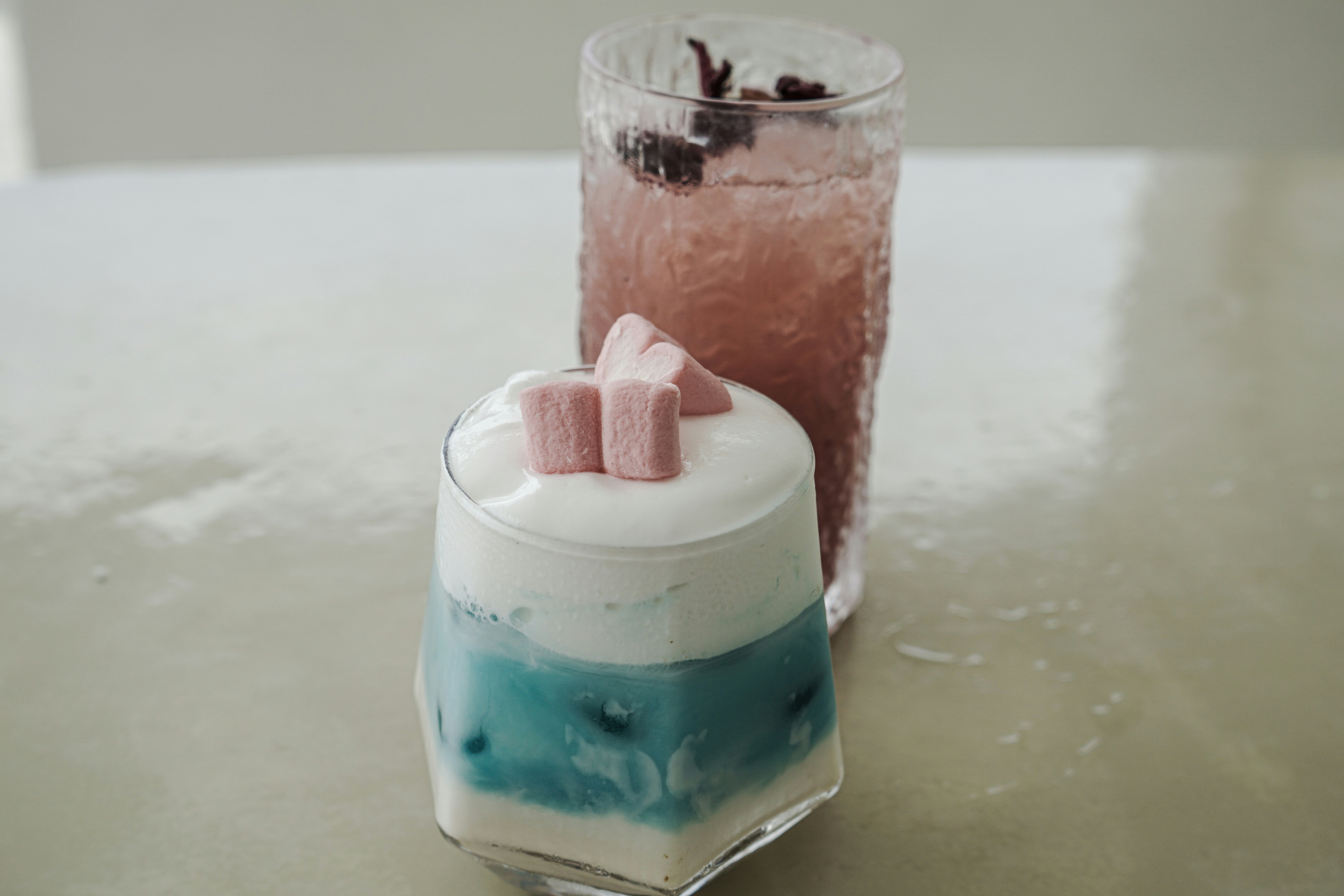 Pastel Triple Treats: Blue Layered Panna Cotta with Pink Marshmallows and Ice-Cube Glow