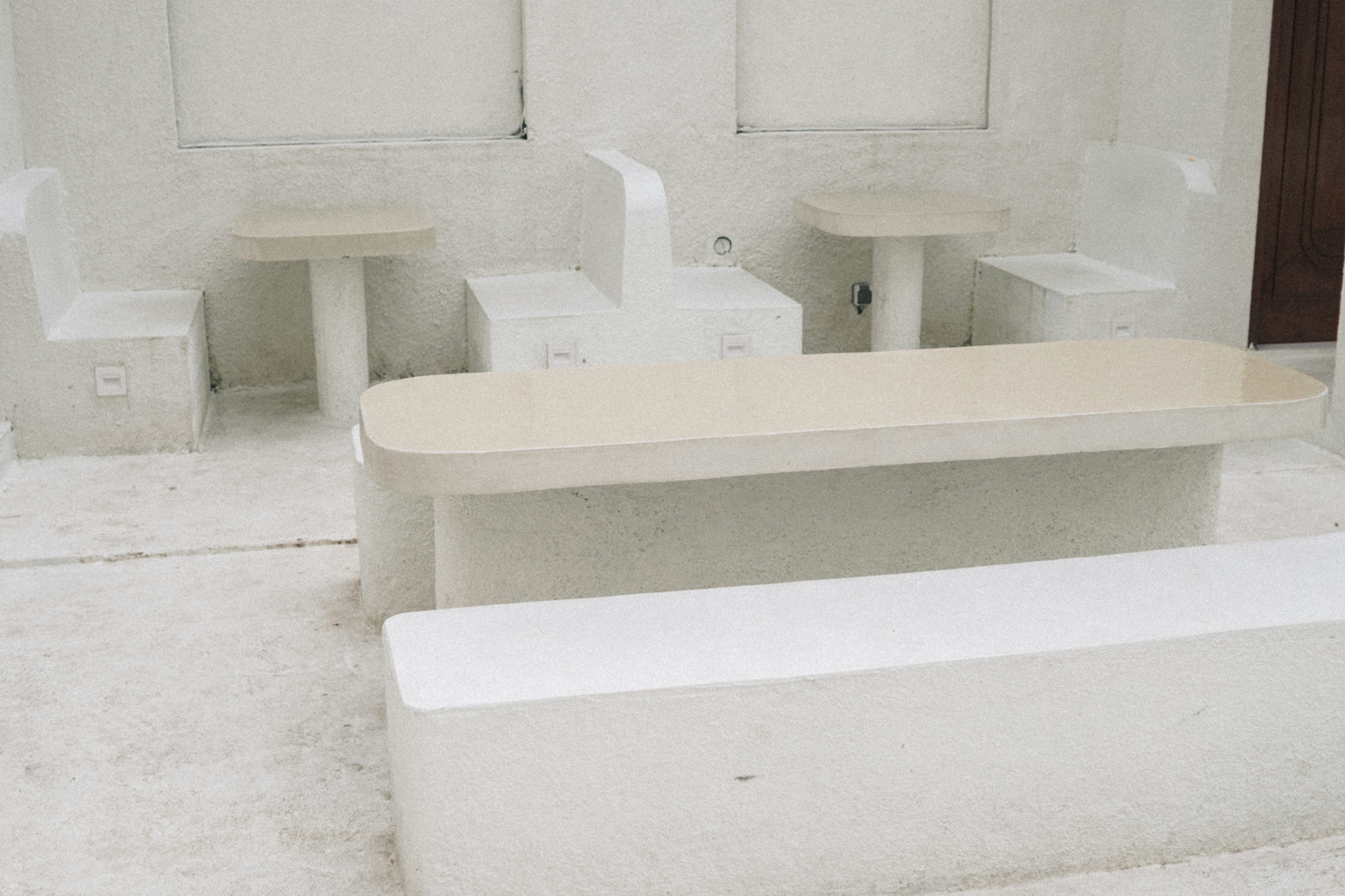 Minimalist White Chamber: Geometric Seating in Soft Light