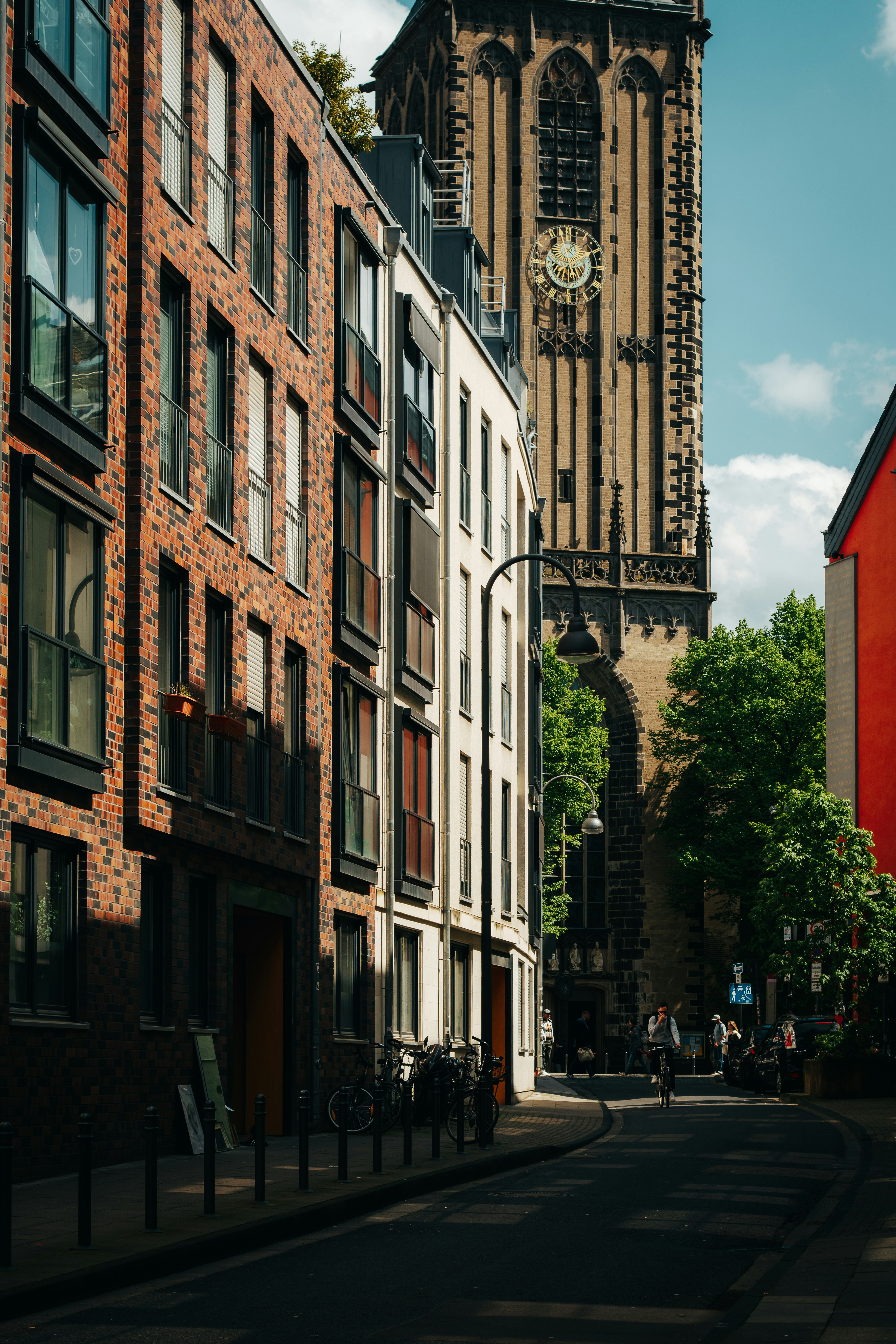 A tall clock tower towering over a city street photo – Free Cologne ...