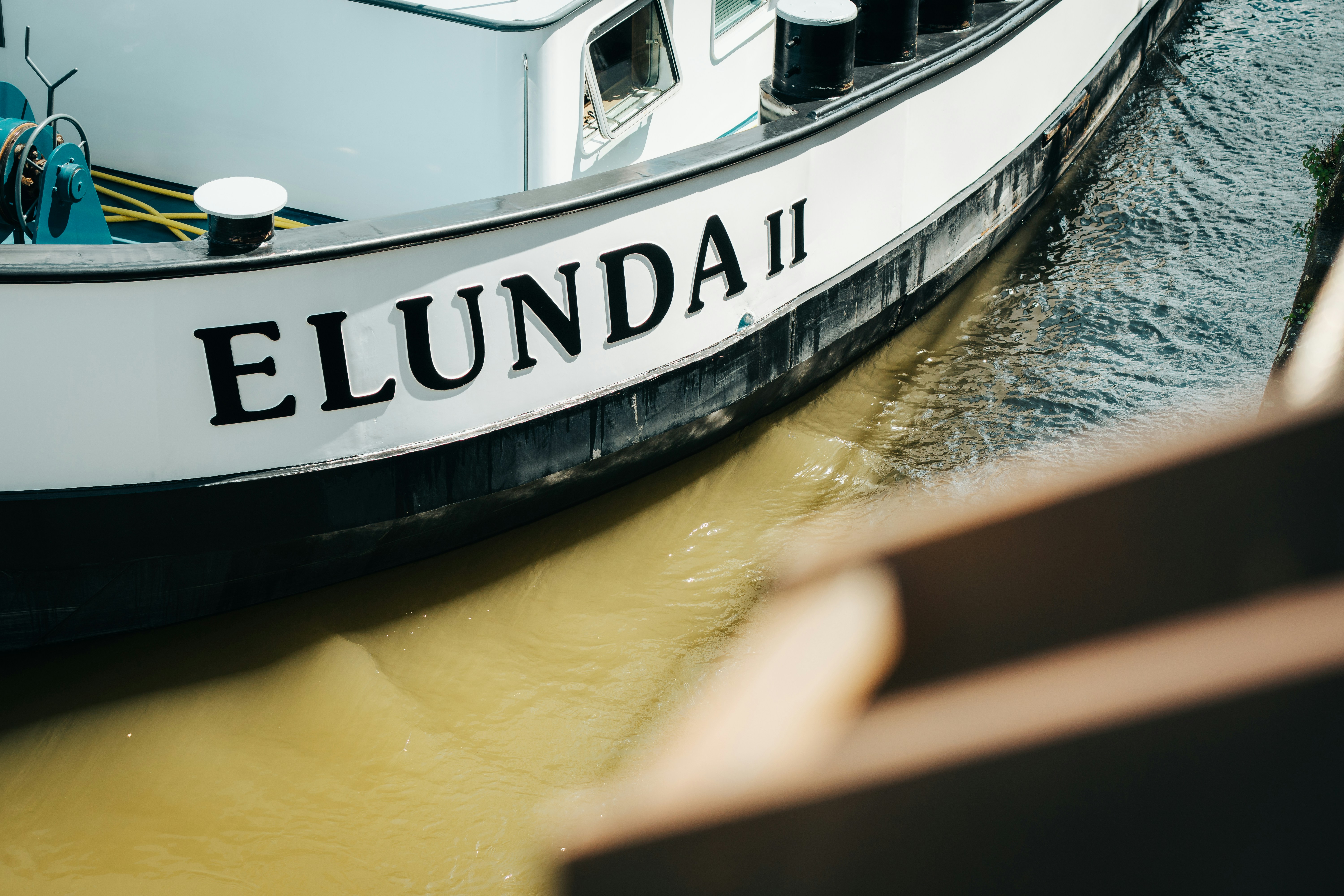 A white and black boat docked at a dock photo – Free Cologne Image on ...
