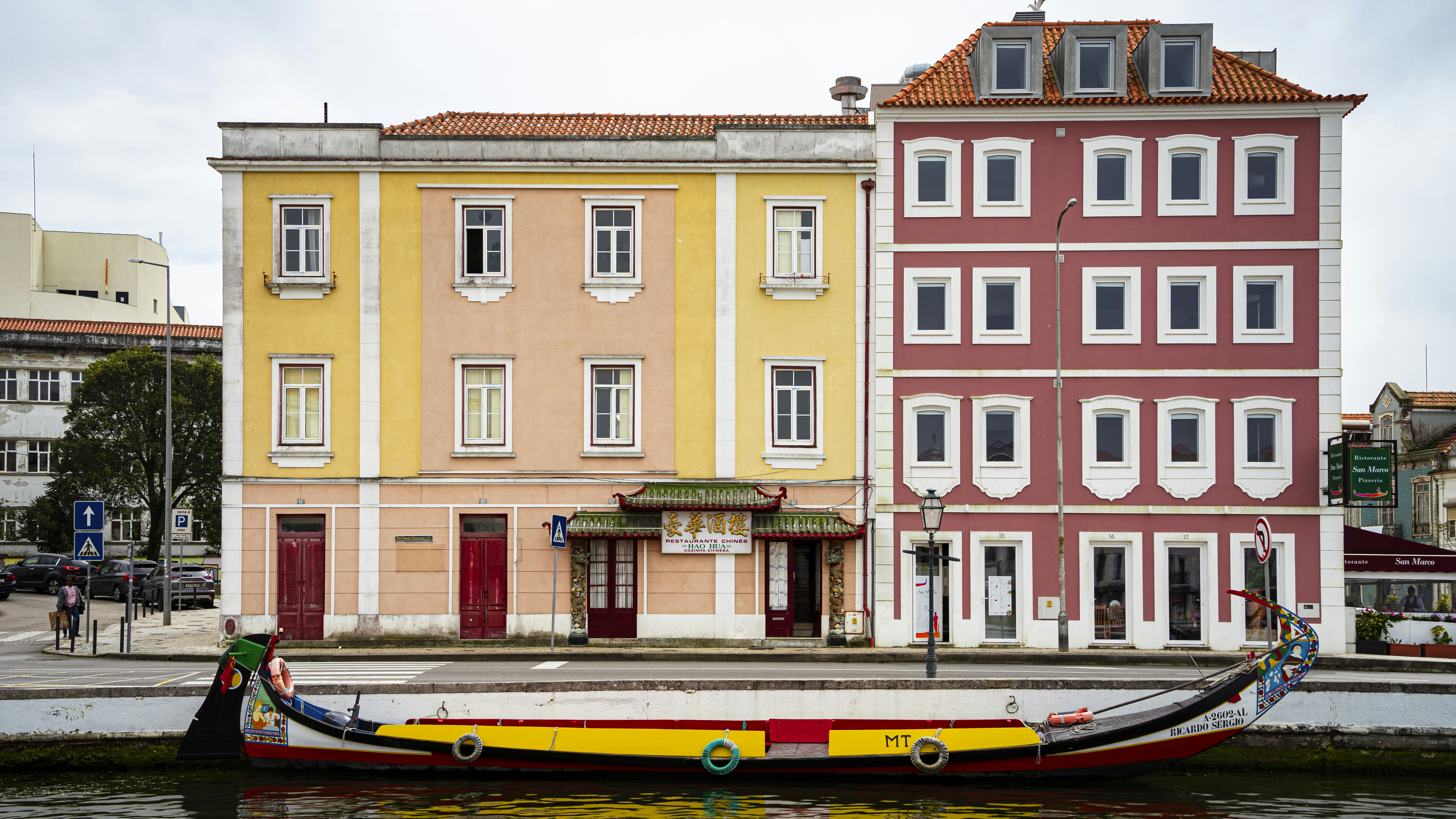 Pastel Townhouses Framing a Sunlit Canal Boat