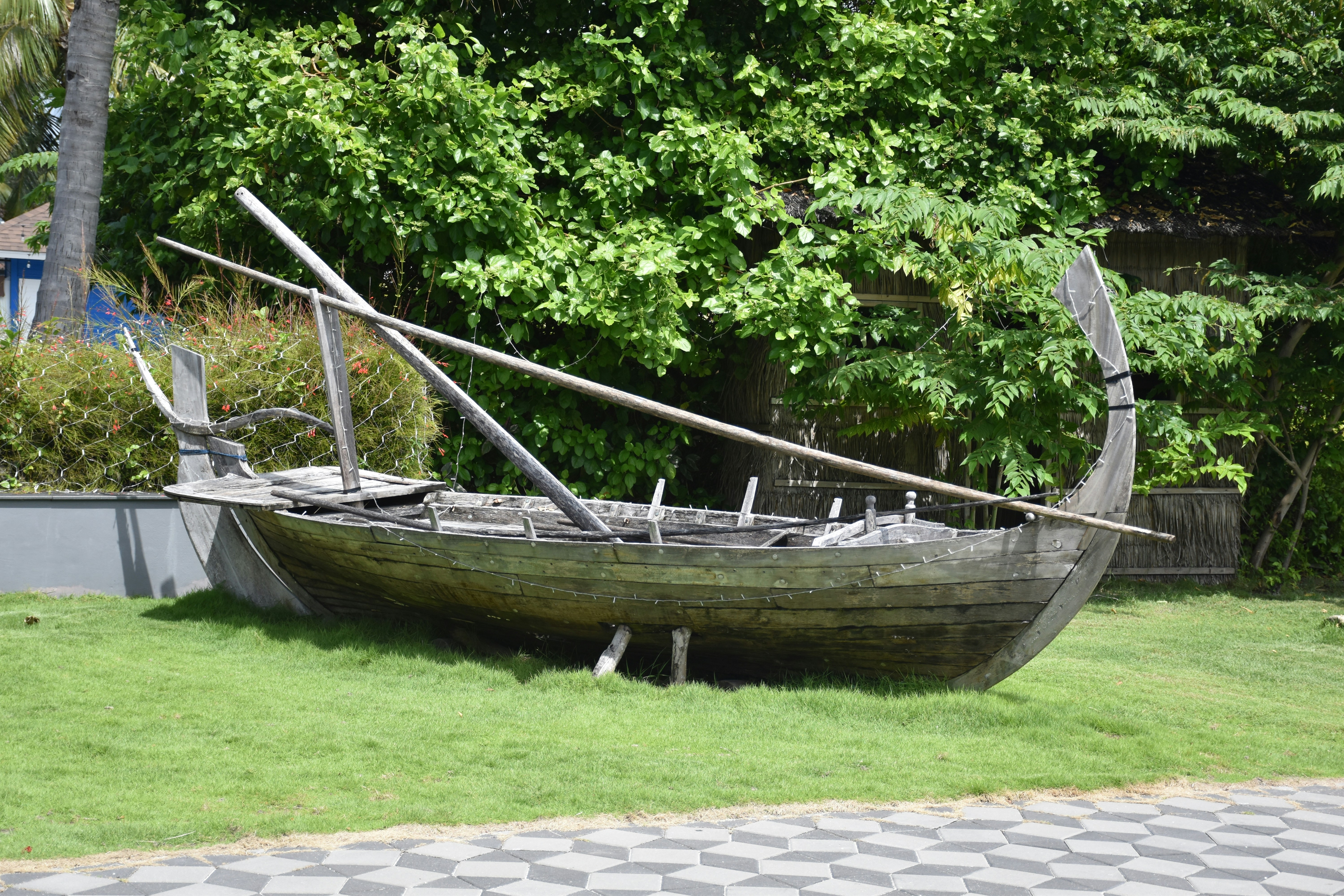 Grassbound Vessel: A Weathered Boat Resting in a Quiet Park Clearing