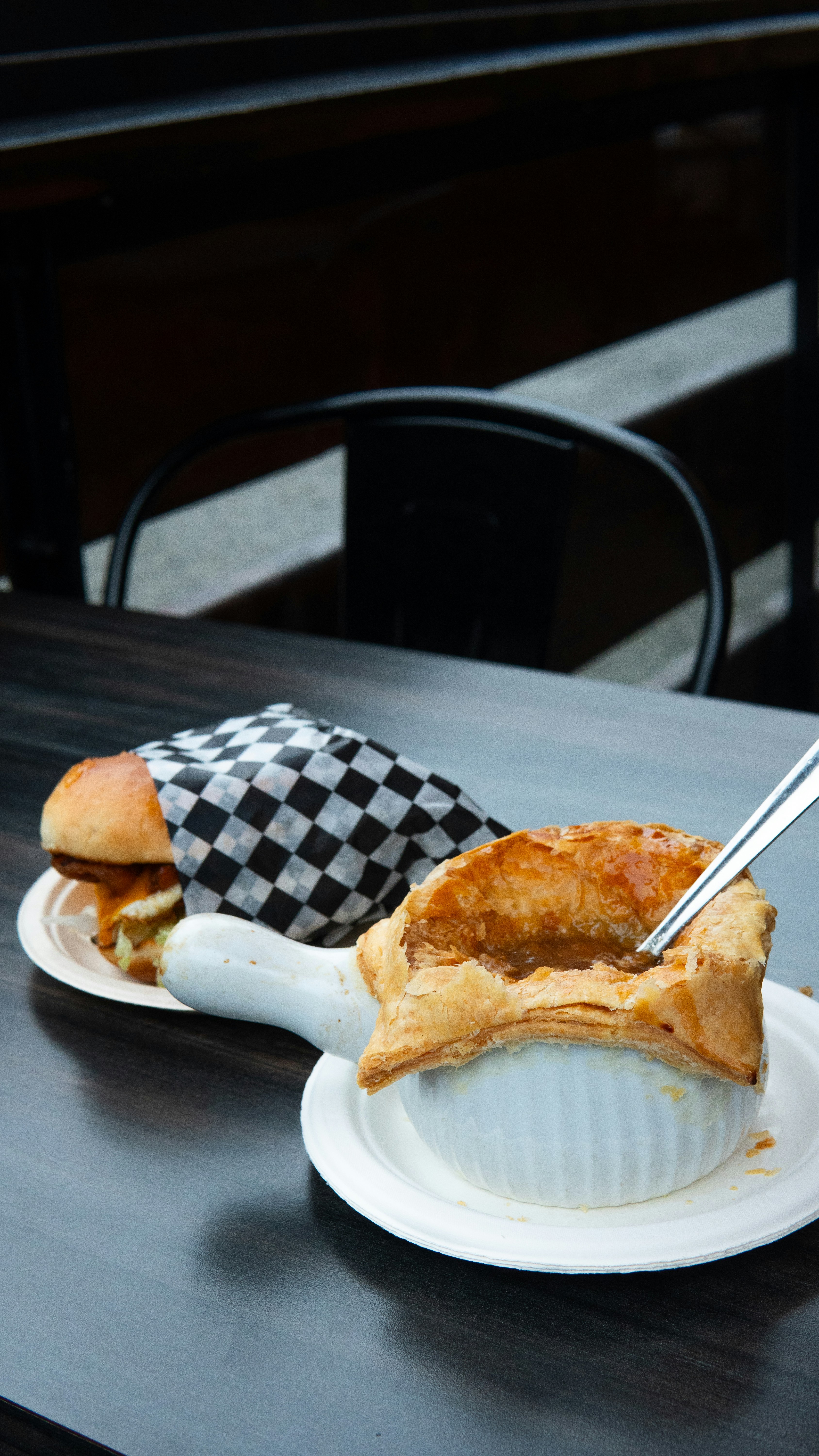 Pot Pie in Focus: Golden Crust Framed by a Checkered Wrap on a Café Table