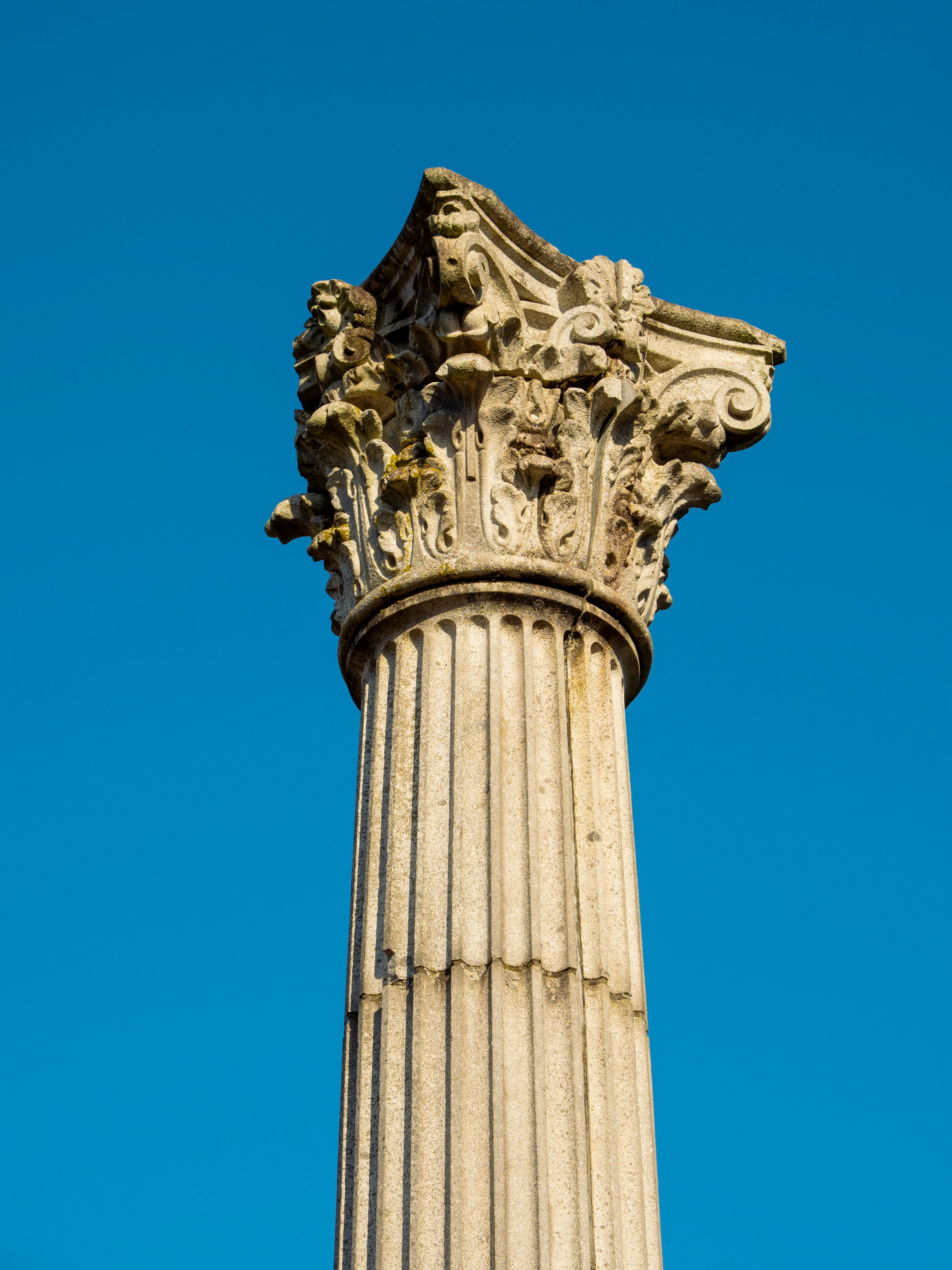 A tall stone column with carvings on the top photo – Free Japan Image ...