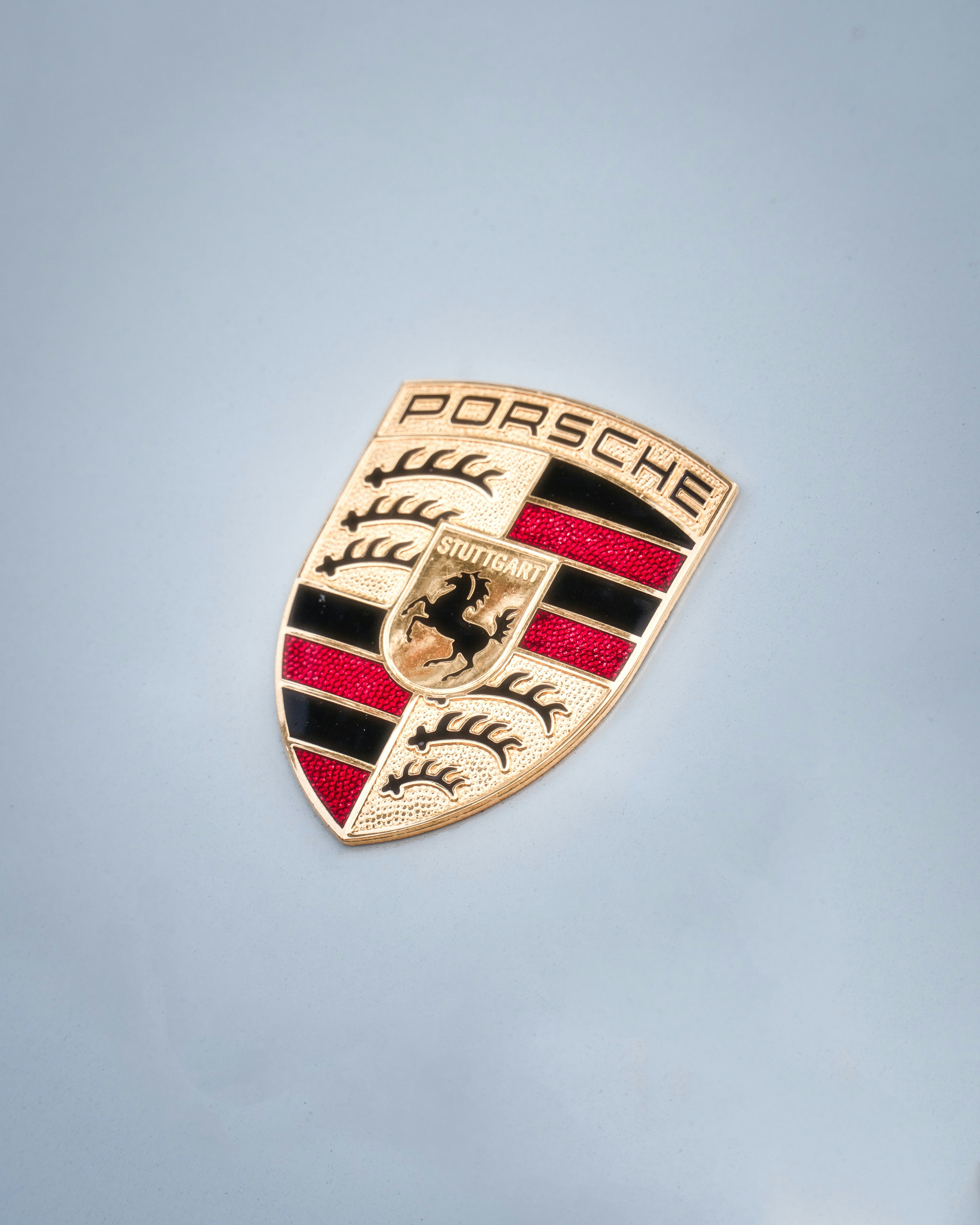 Pastel Backdrop Frames a Gleaming Porsche Crest