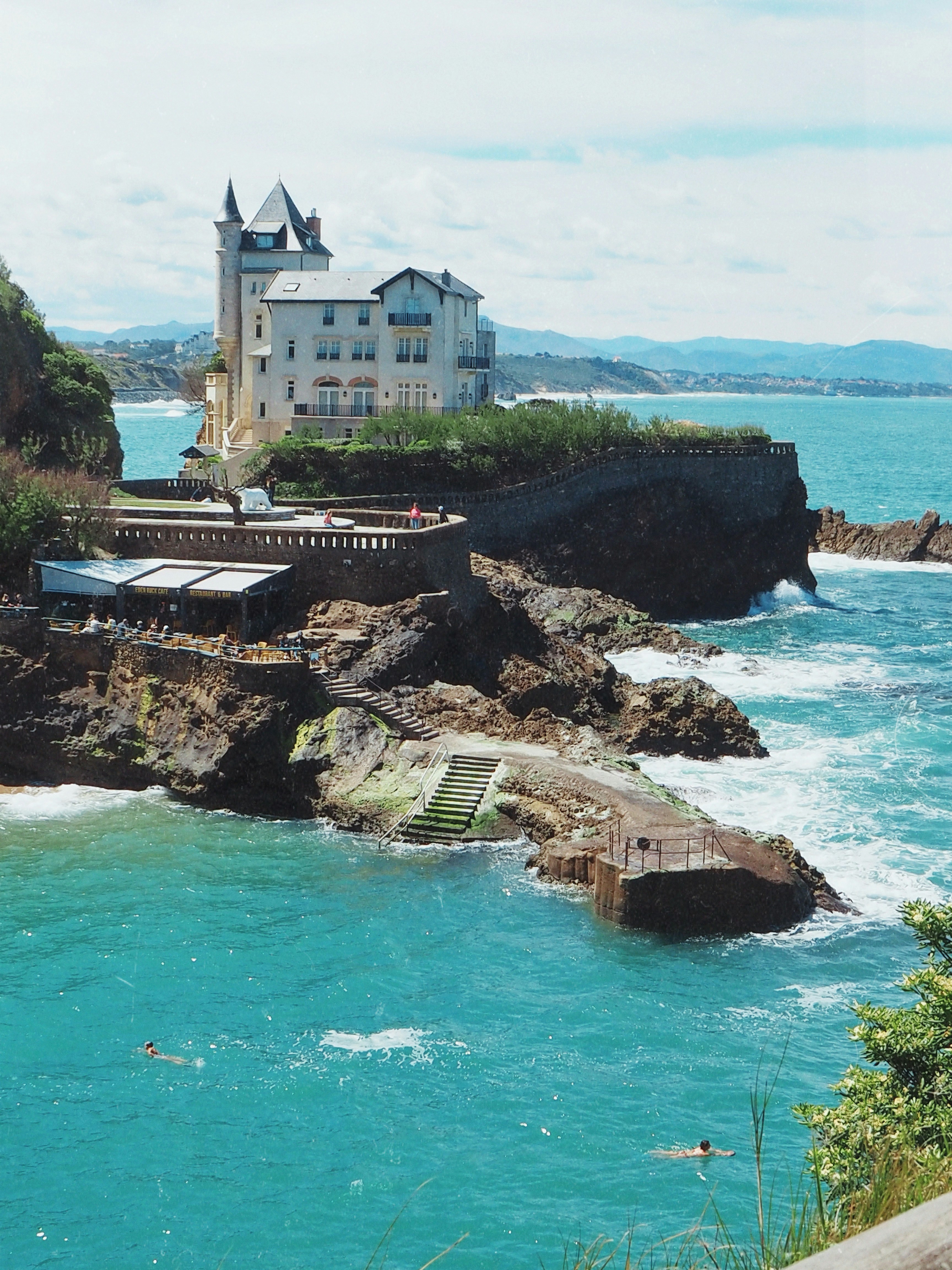 Turreted Castle on a Cliff Over Turquoise Sea