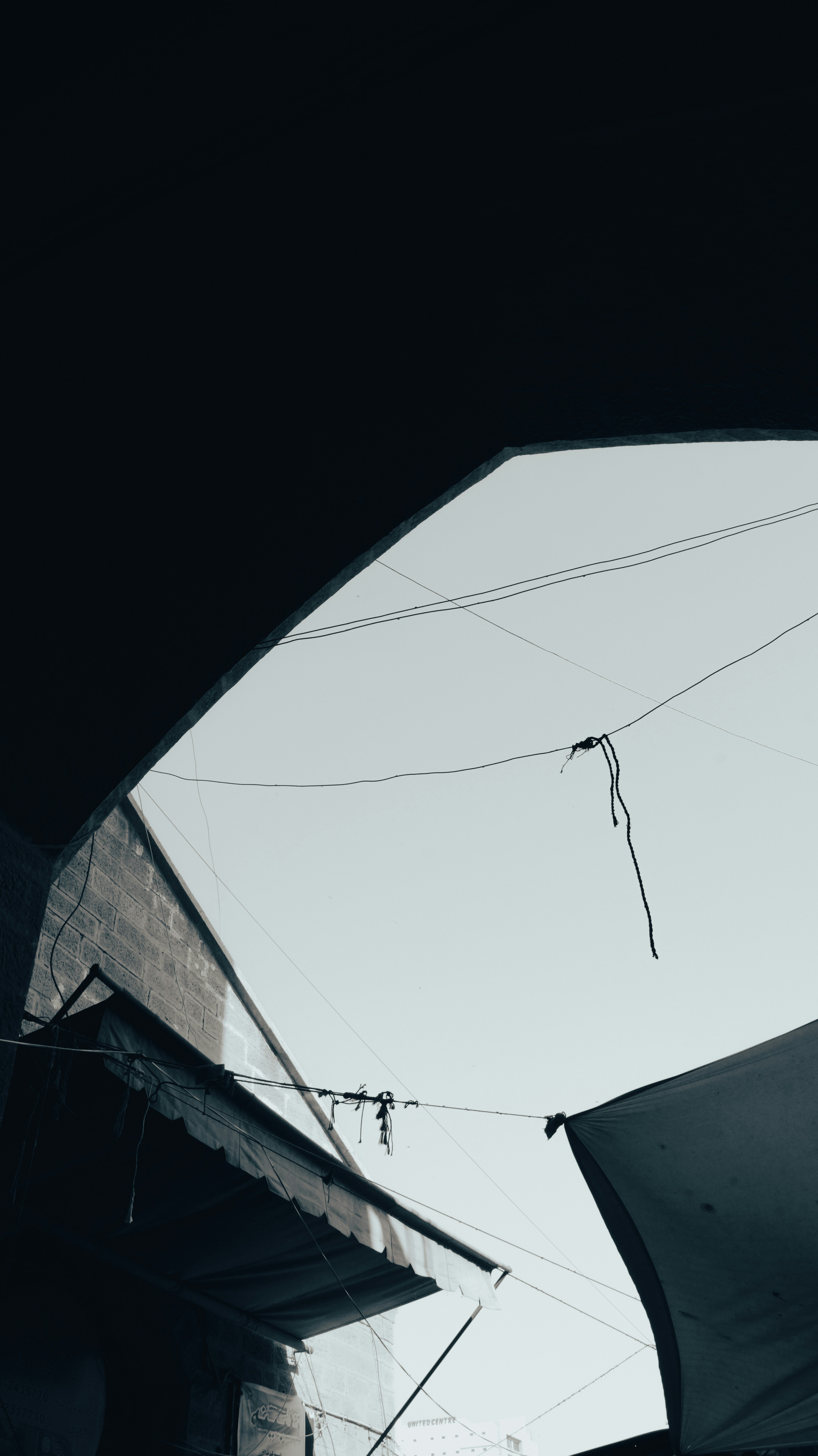 Opening Lines: An Archway Framing Light and Wires in a Quiet Urban Moment