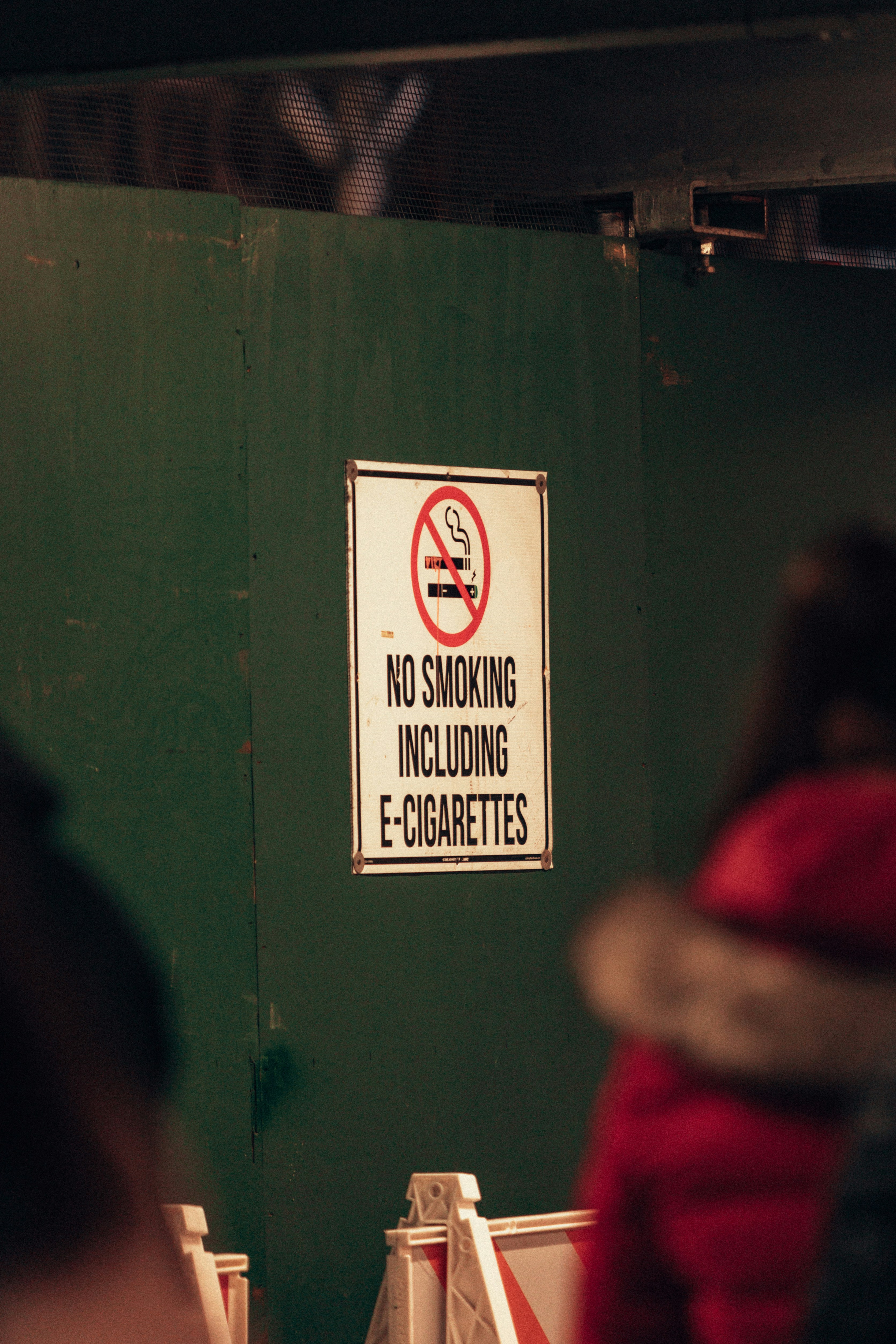 No Smoking Sign Anchored on a Green Corridor