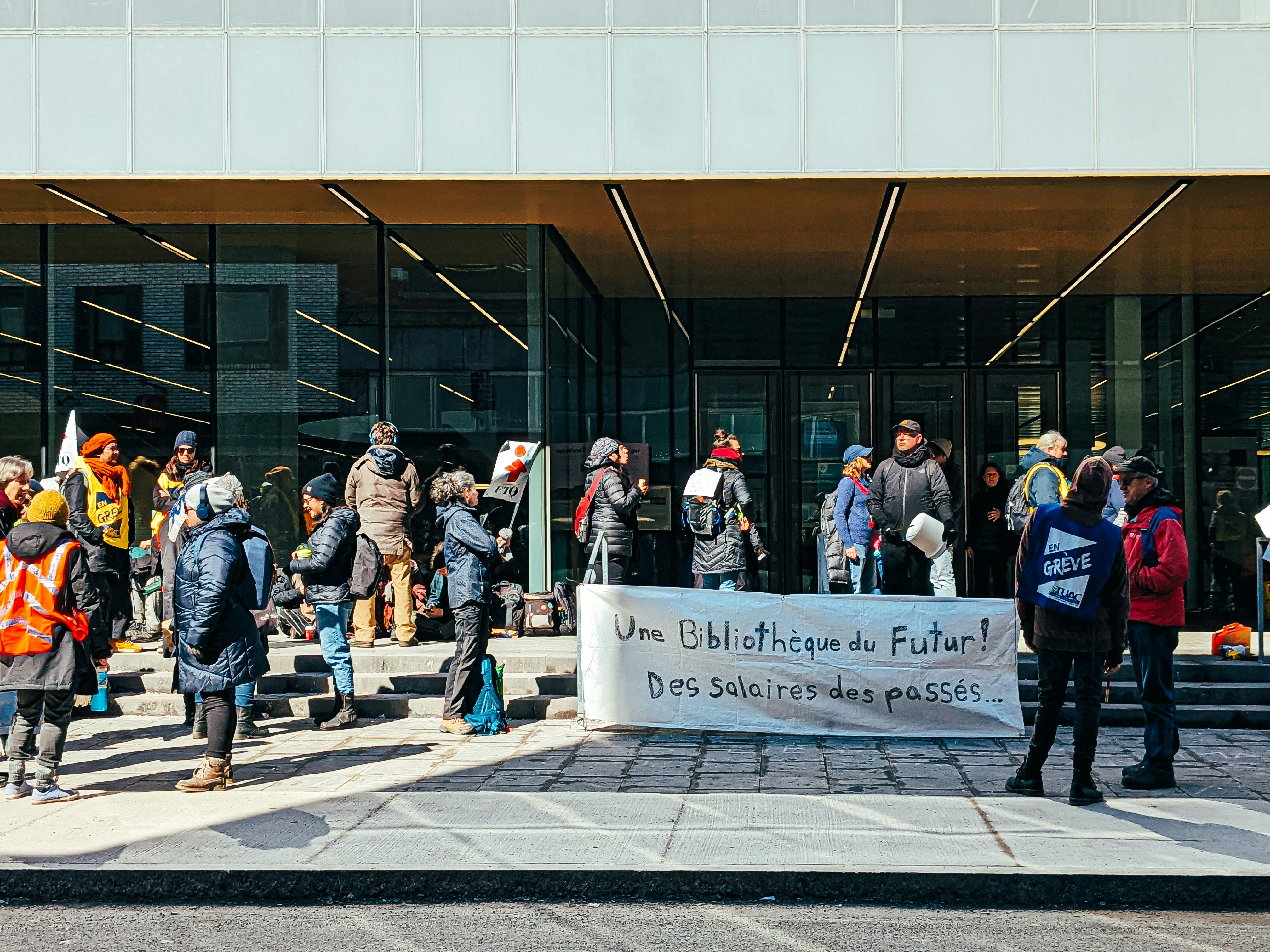 A group of people standing outside of a building photo – Free Human ...