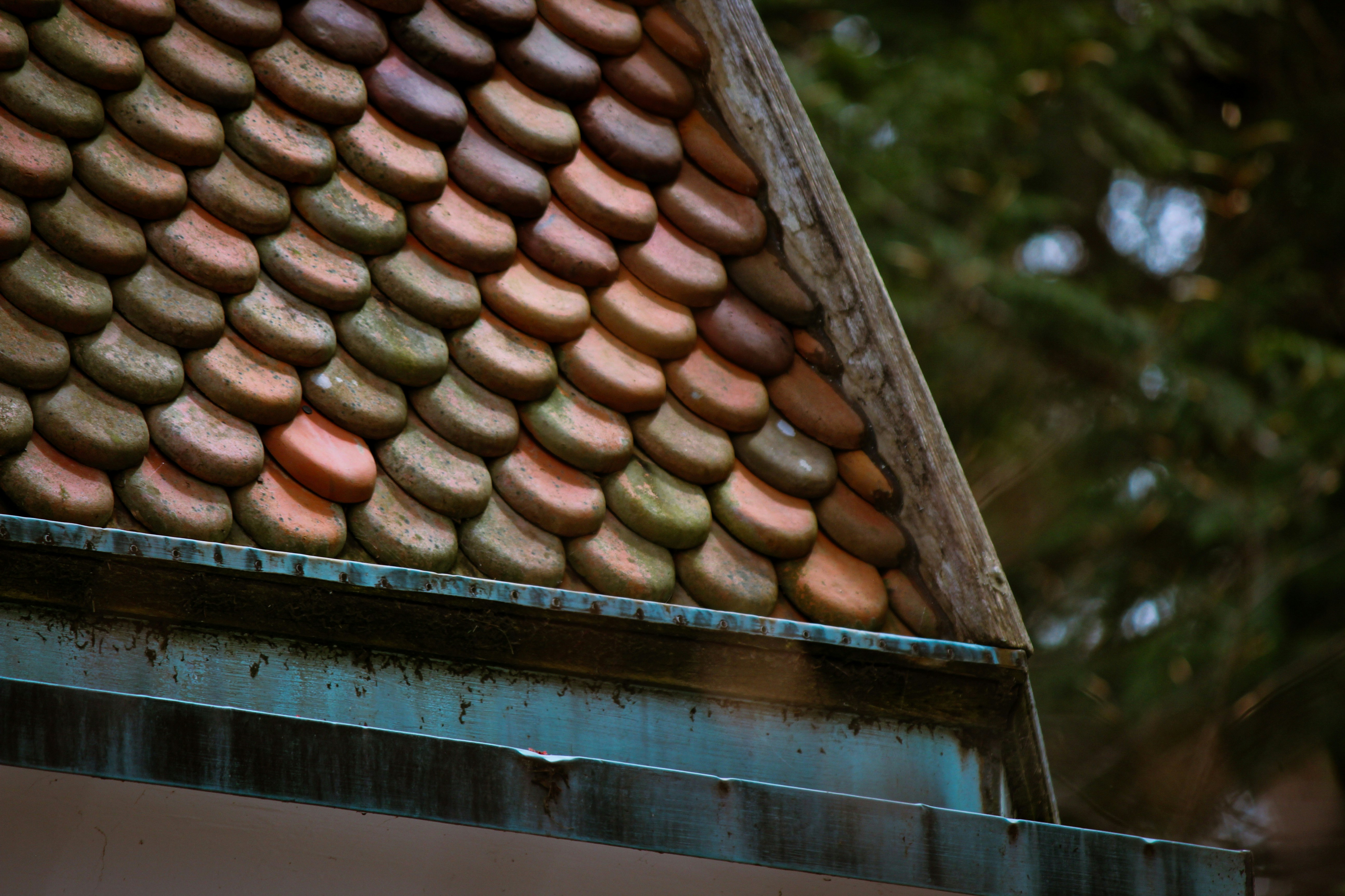 Earthy Clay Tile Mosaic Along a Weathered Roof Edge