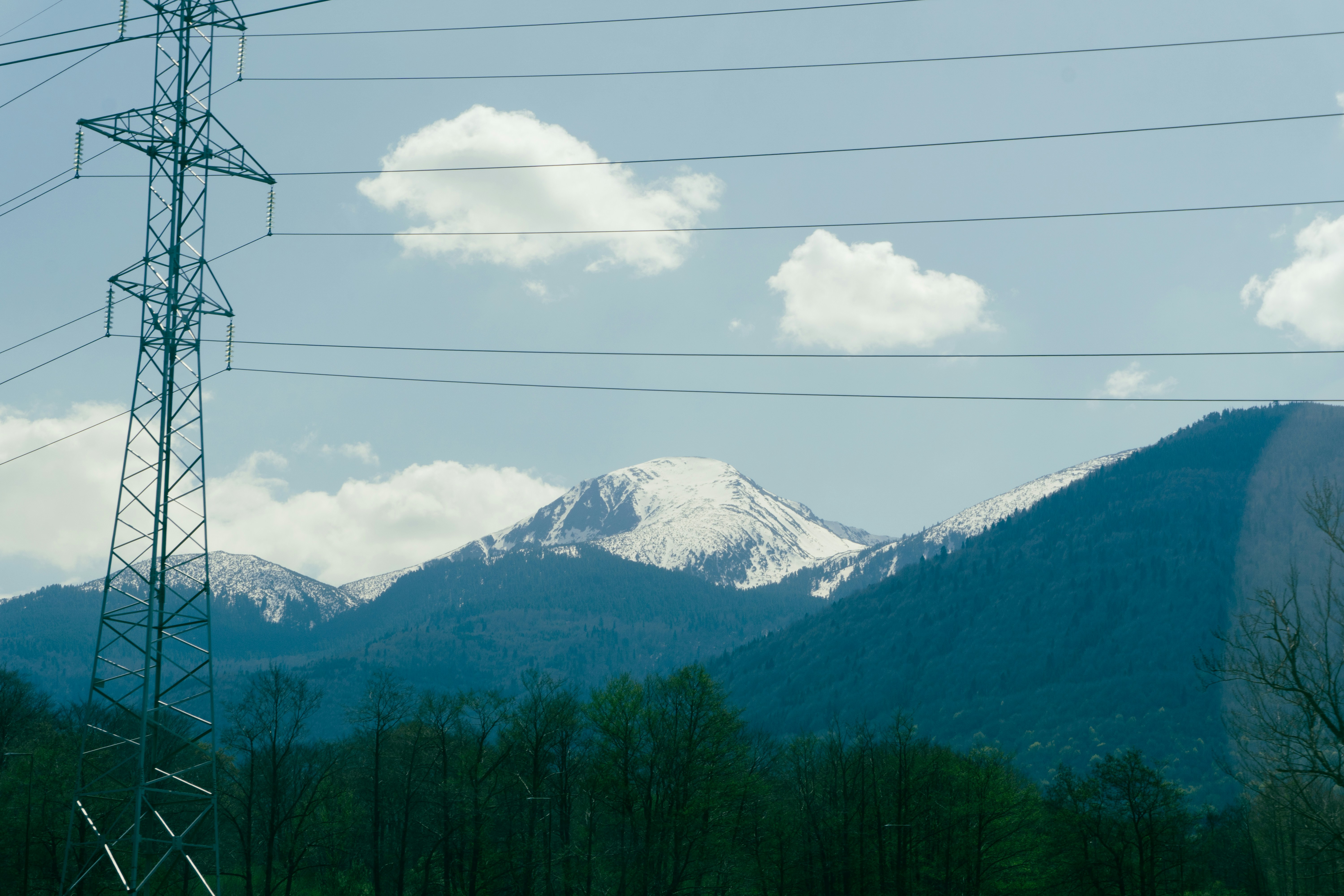 a view of a mountain range with power lines in the foreground