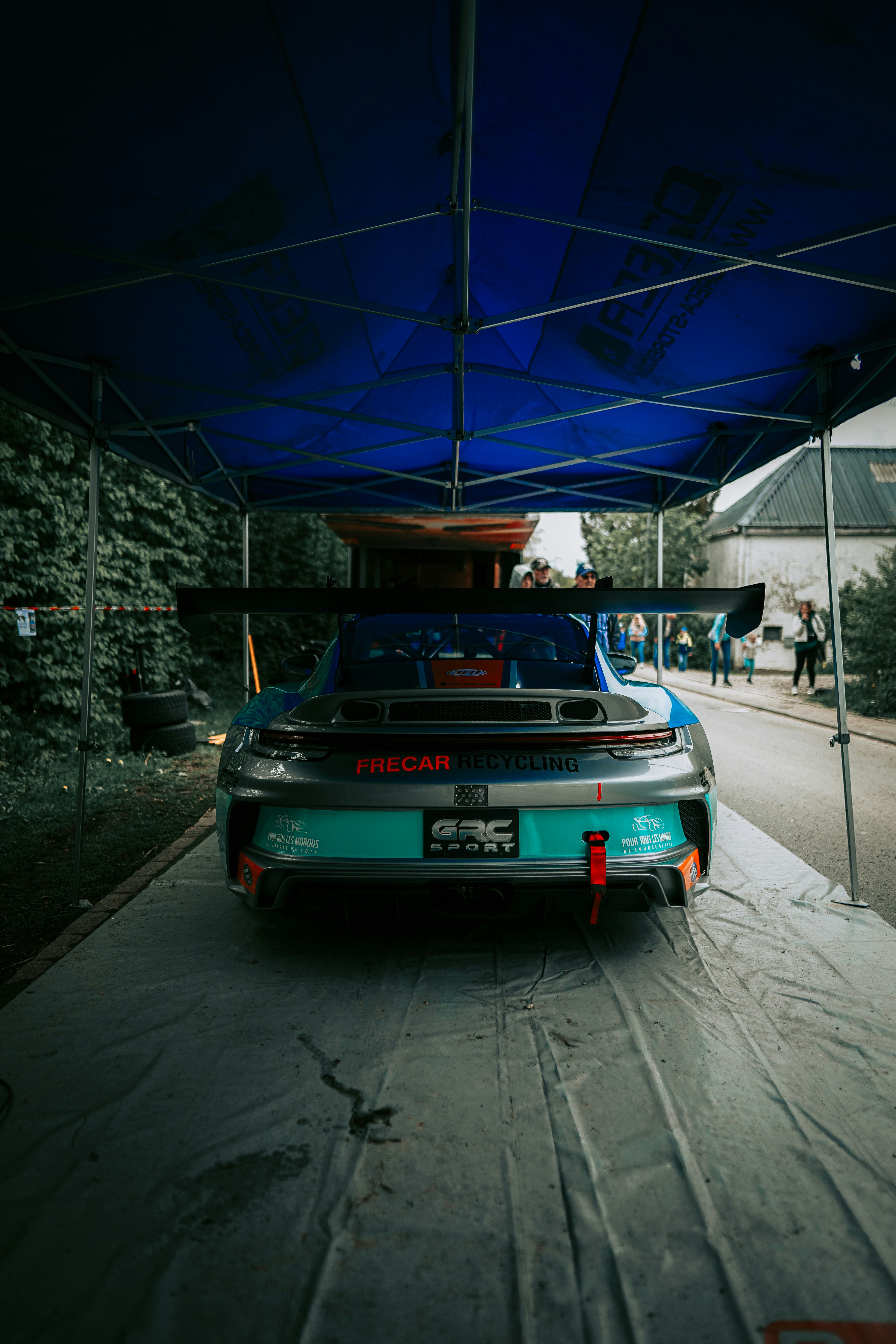 Under the cobalt canopy: Rally car in the pit