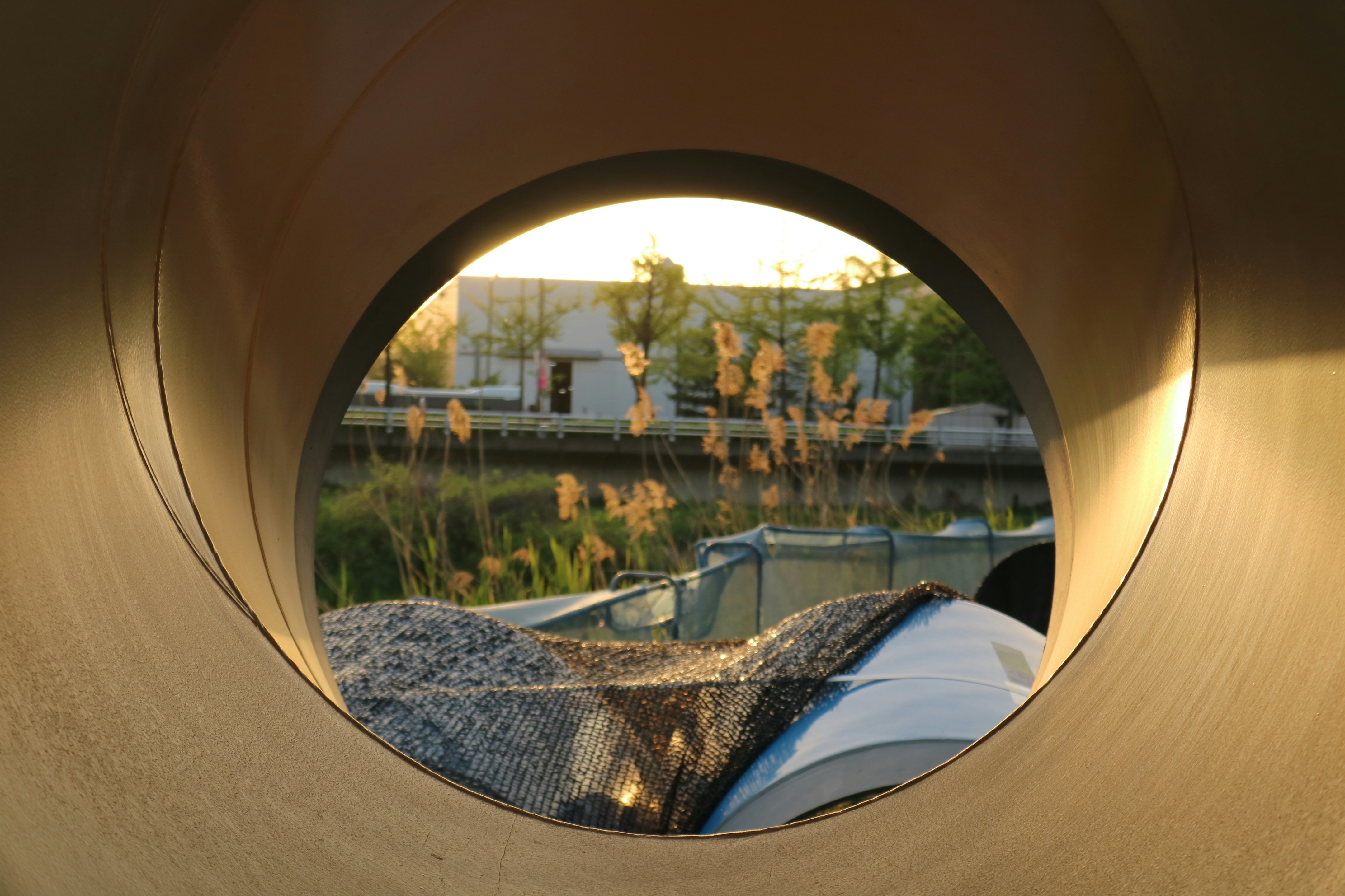 Circular View: Soft Light Through a Pipe at Dusk