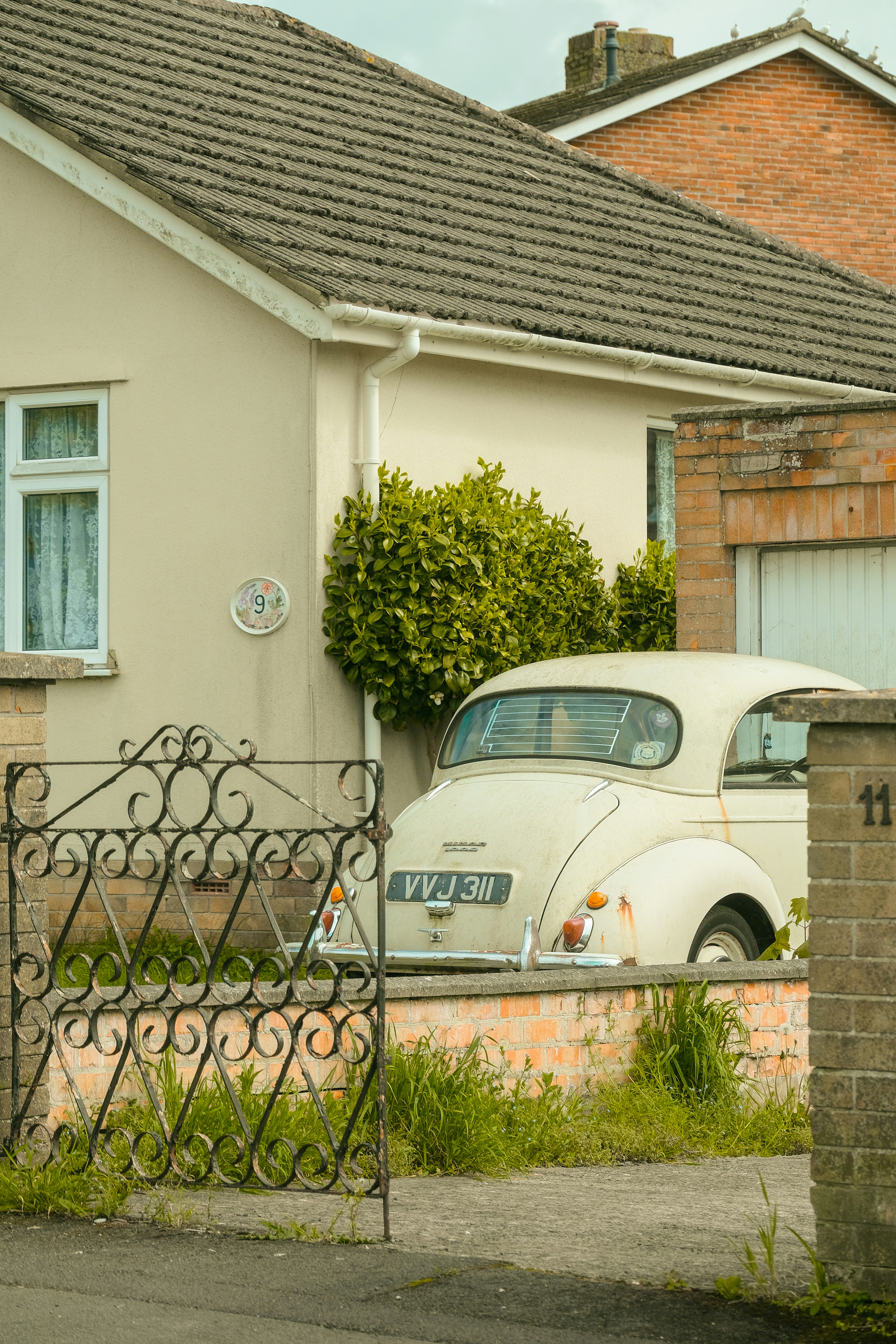A white car parked in front of a house photo – Free Retro car Image on ...