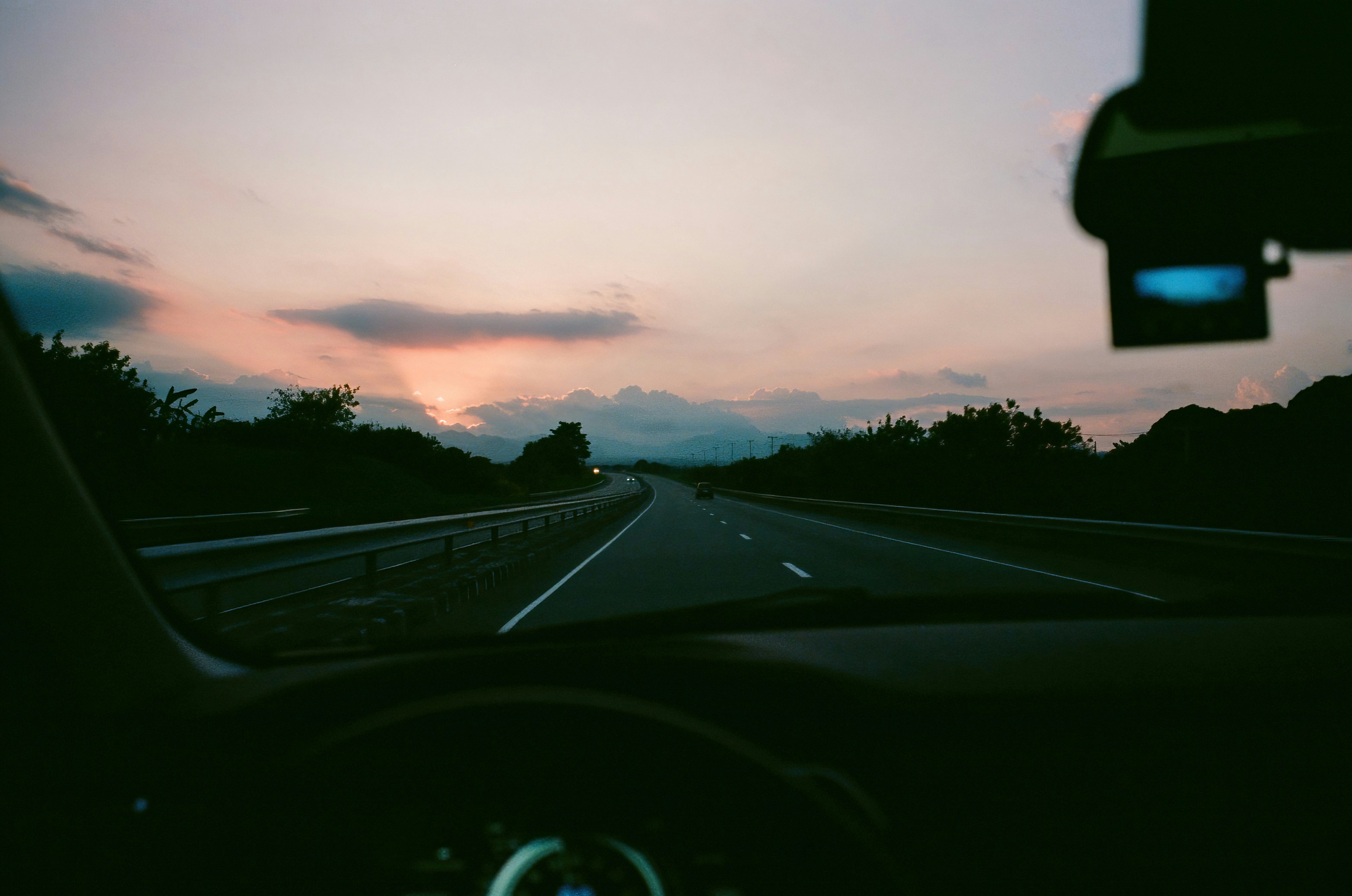 A car driving down a highway at dusk photo – Free Film photo Image on ...