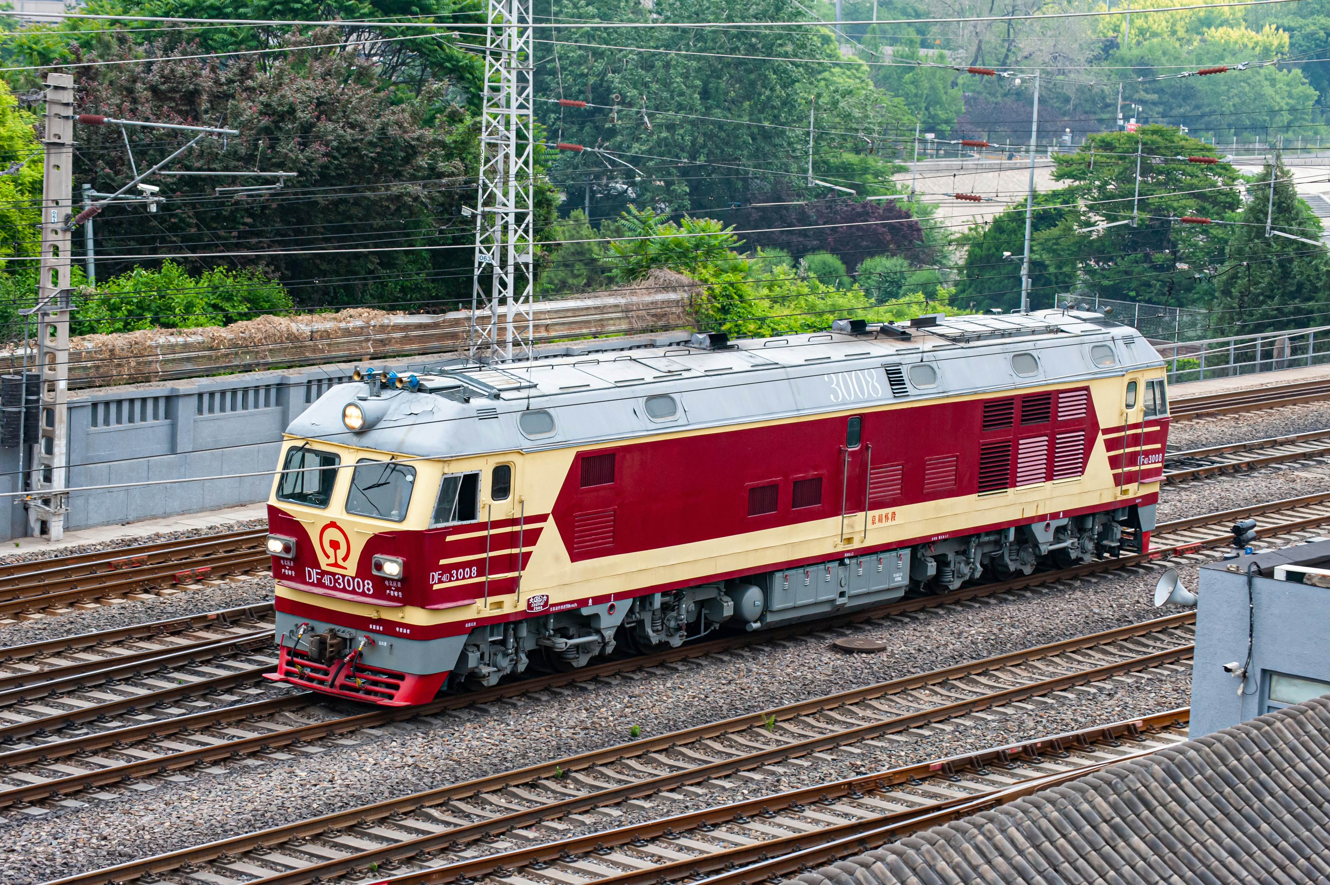 A red and yellow train traveling down train tracks photo – Free ...