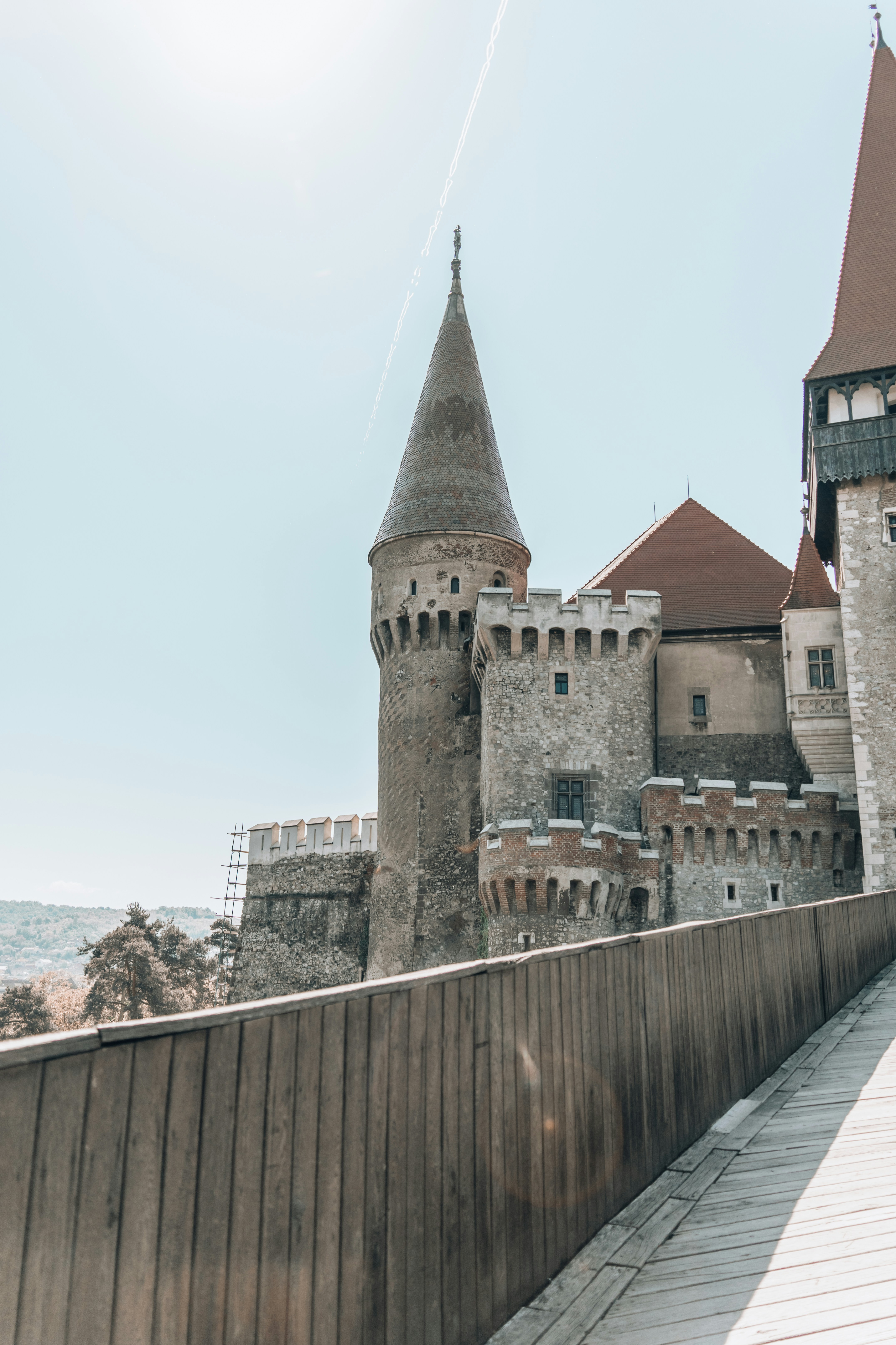 A large castle with a tall tower next to a body of water photo – Free ...