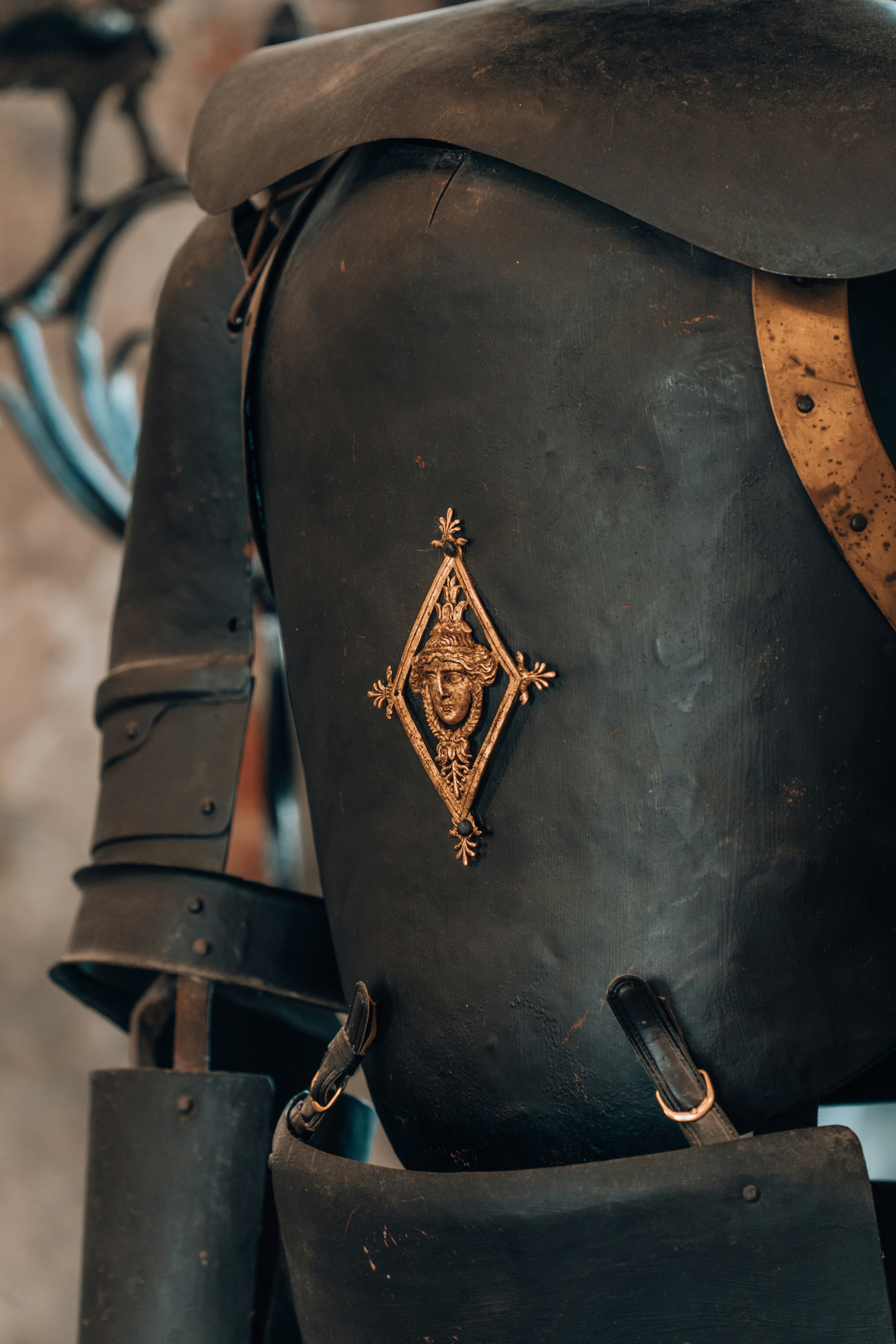 Diamond Crest on a Weathered Cuirass: A Close-Up of Armor Patina