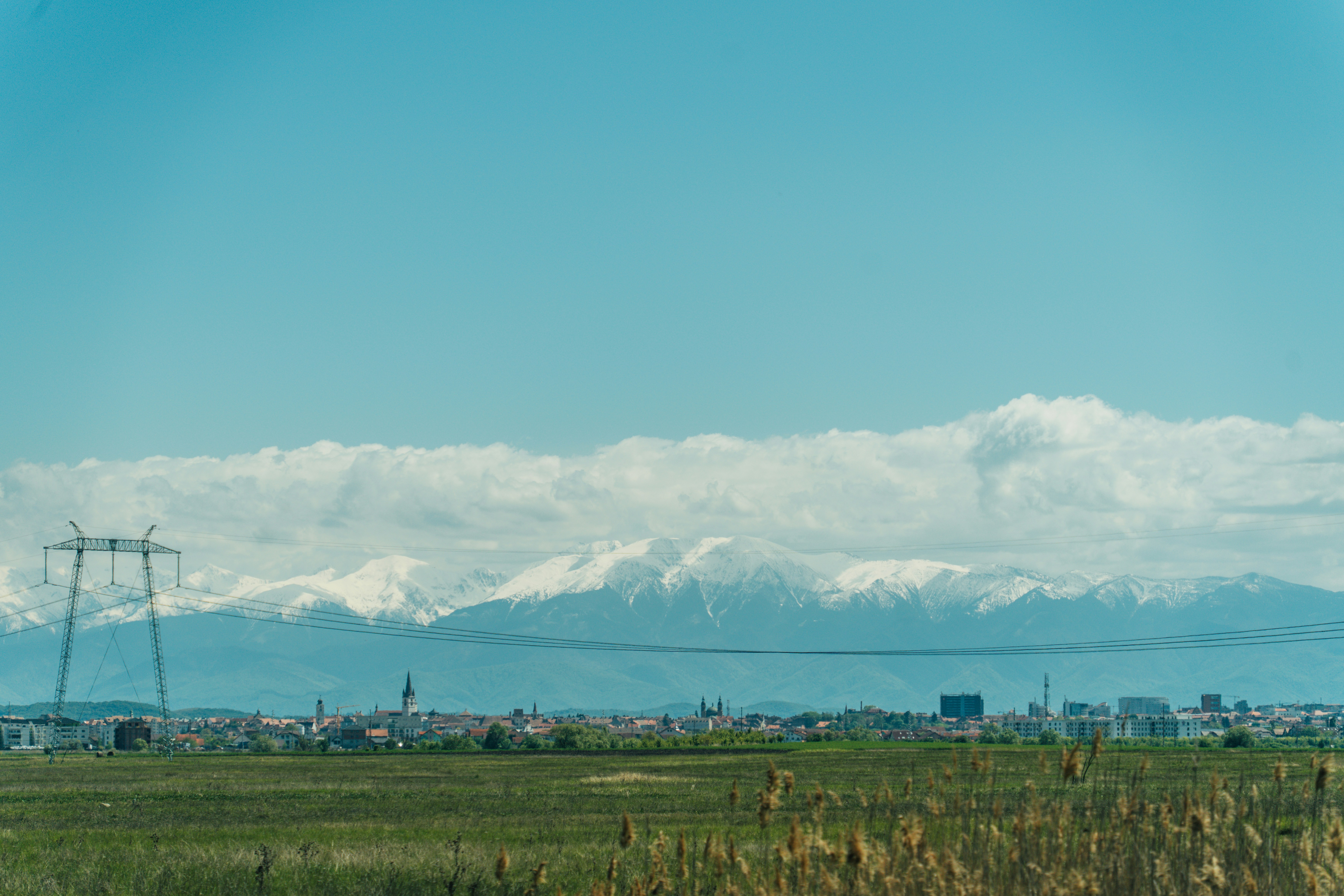Snow-Dusted Peaks Framing a Quiet Prairie Horizon