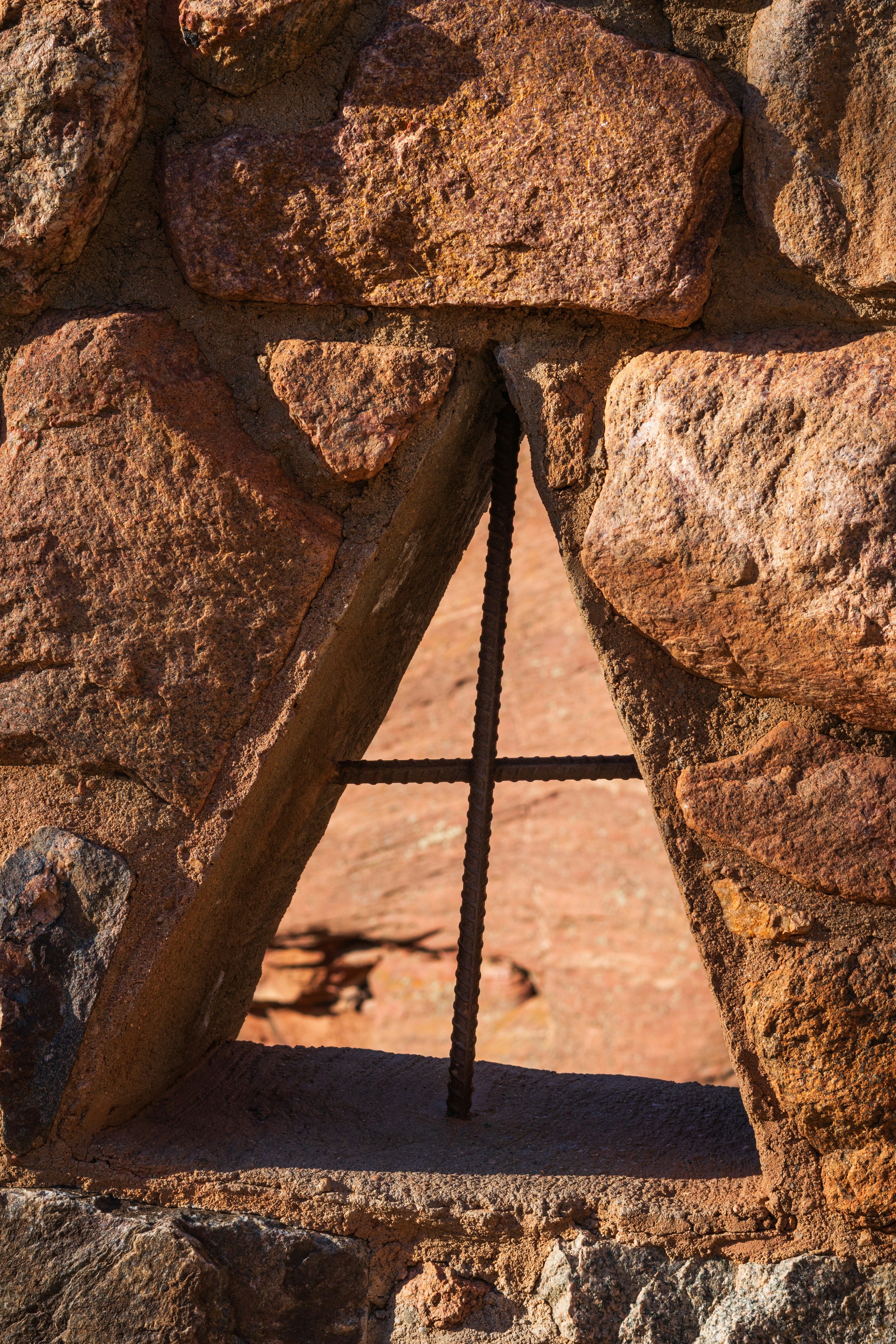 Triangle of Time: Desert Ruin Framed by Rusted Rebar