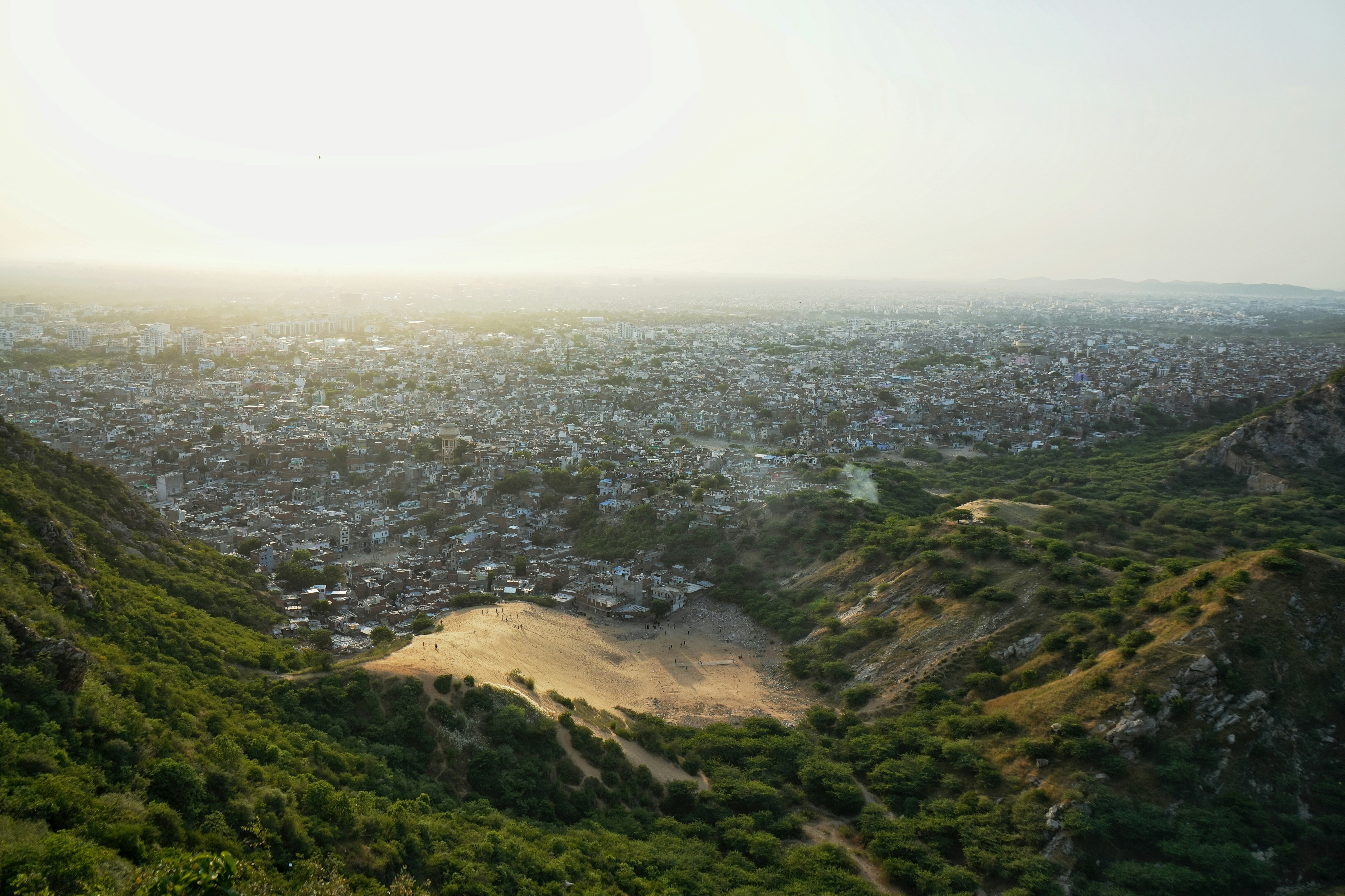 Sunlit Quarry Framing a Valley Cityscape
