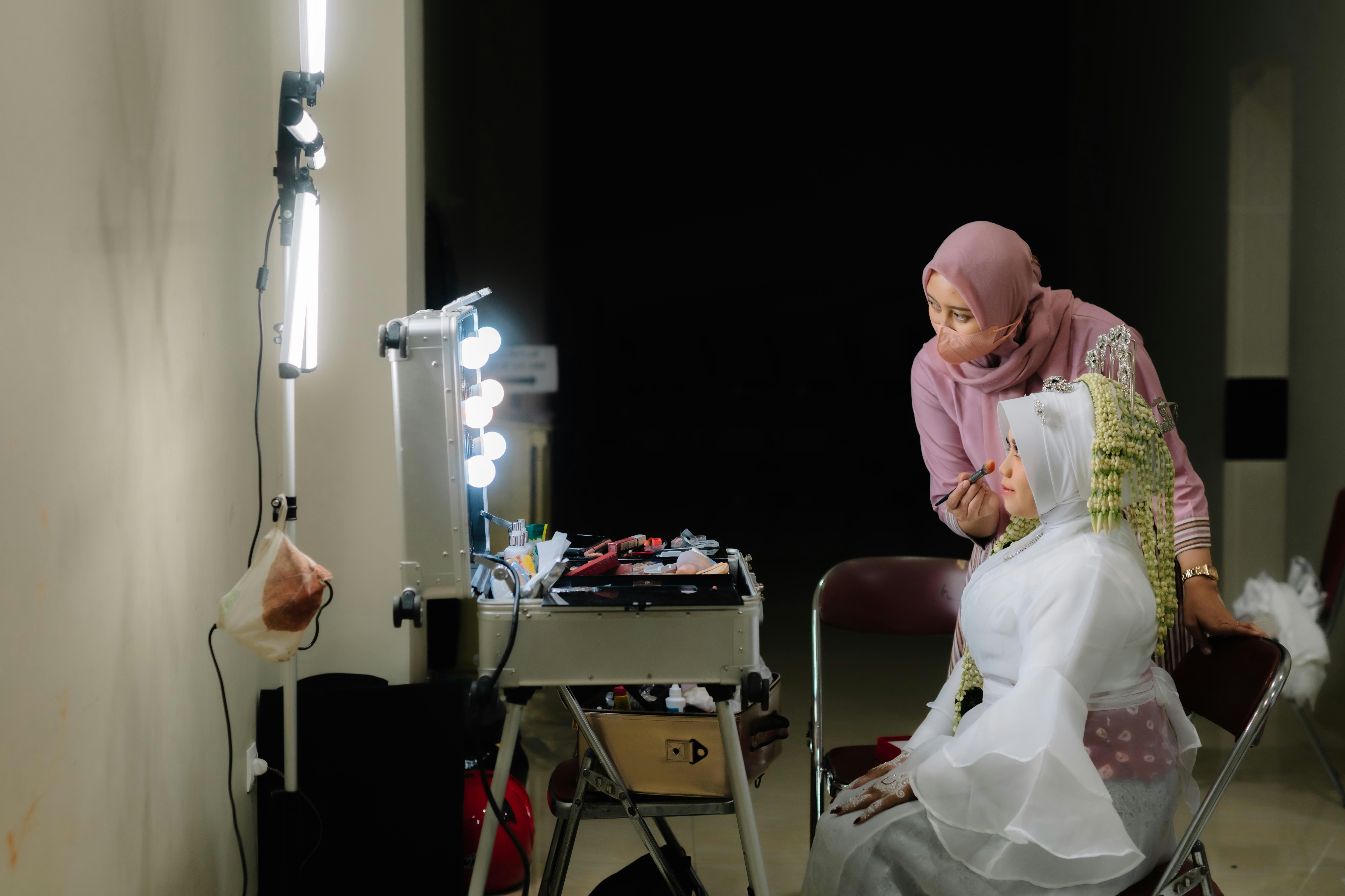 A woman sitting in a chair in front of a mirror photo – Free Woman Image on Unsplash