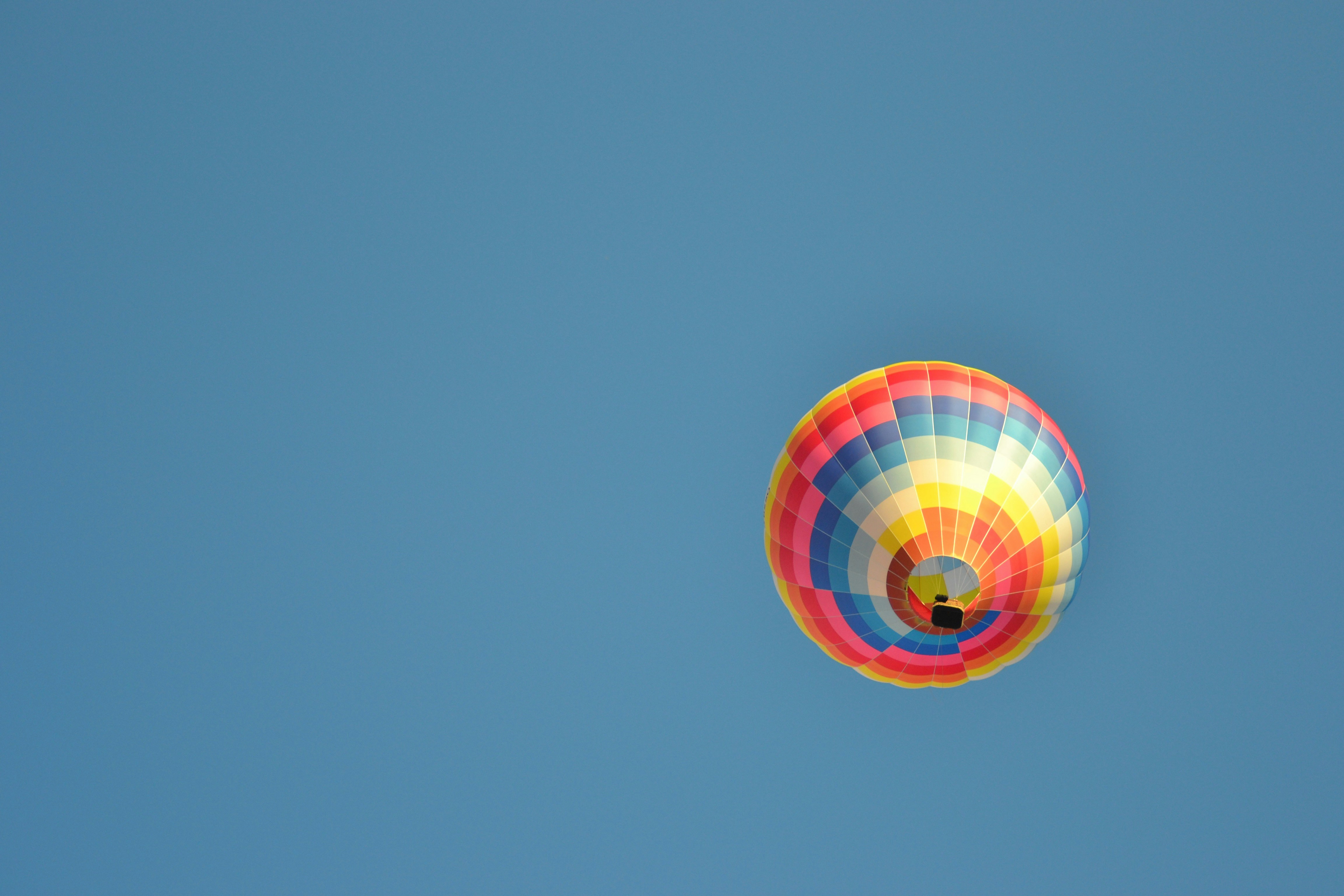Rainbow Balloon Gliding Across a Cerulean Sky