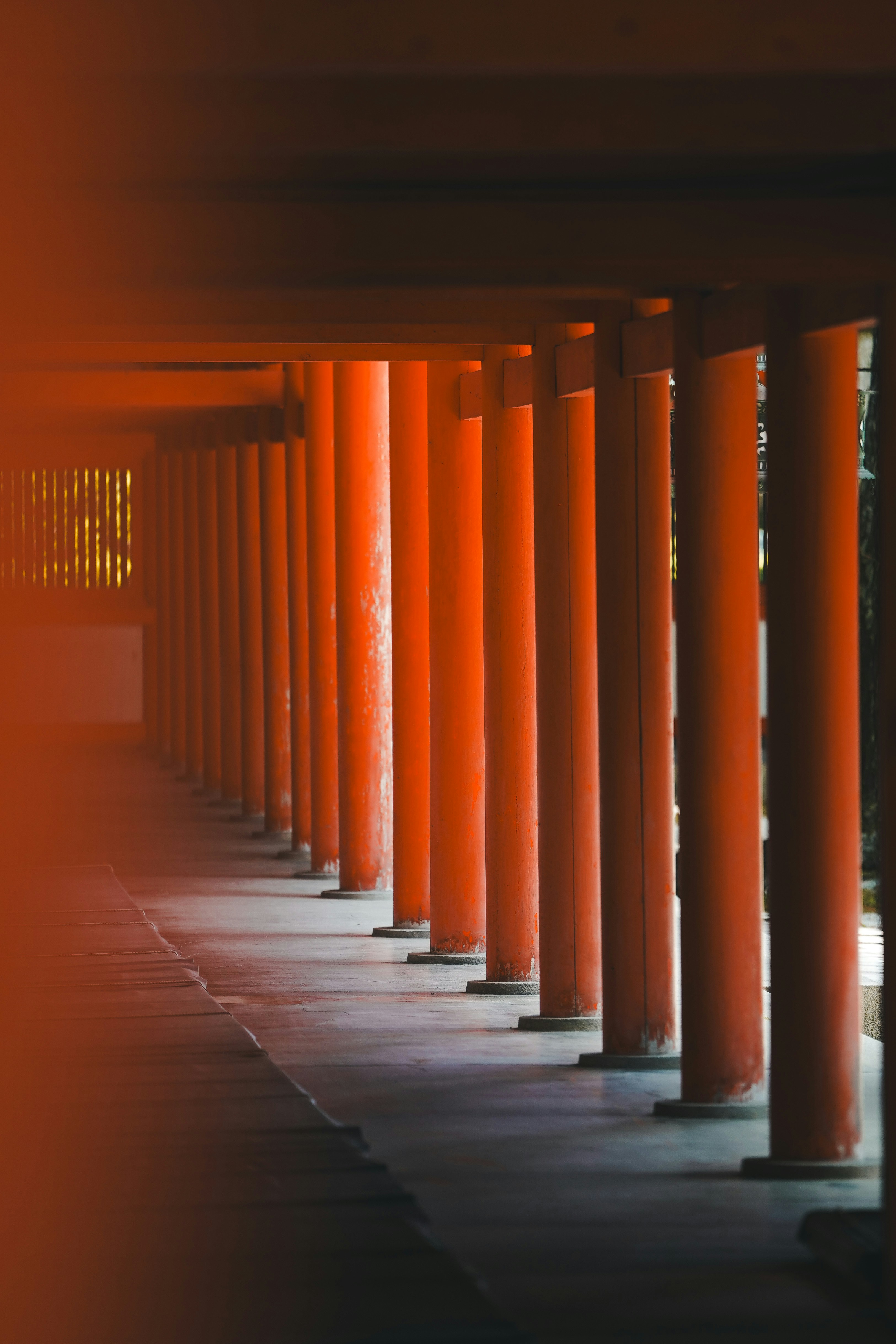 Vermilion Corridor: Receding Columns Under Quiet Light
