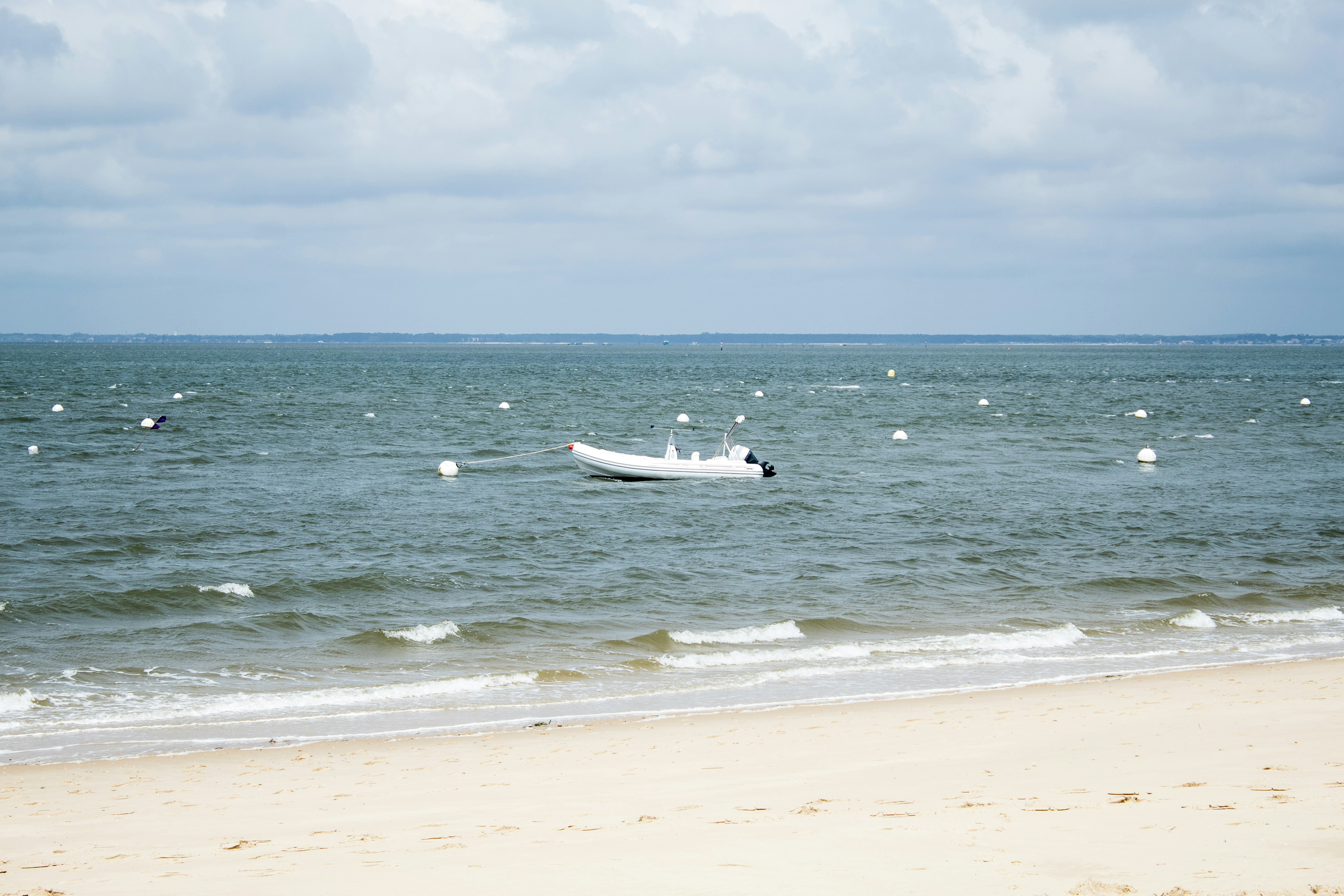 Lone White Boat on a Quiet Coastal Canvas