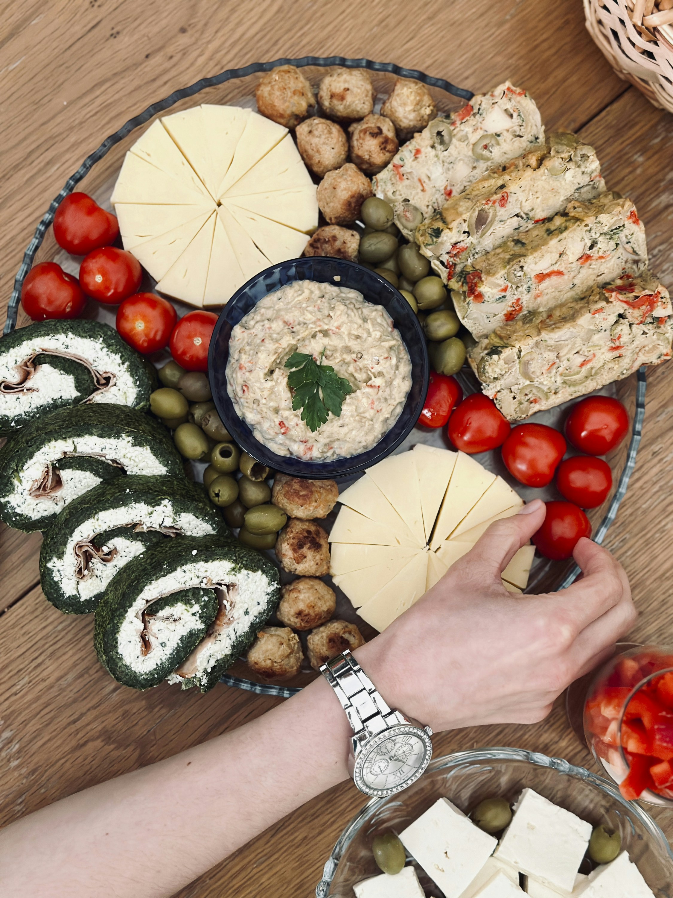 Charcuterie Carousel: A Hand Reaches for Slices of Cheese