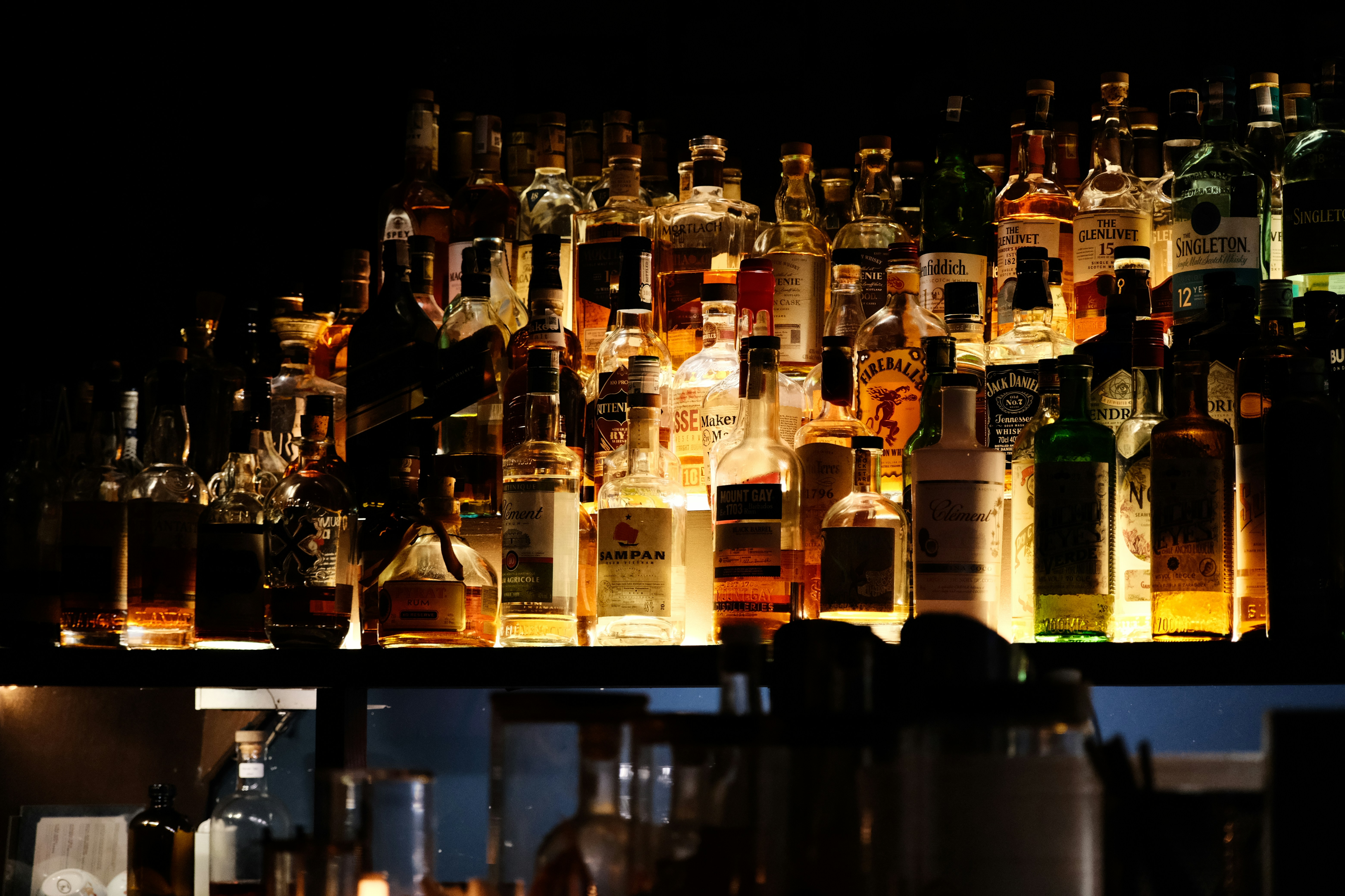 A large amount of bottles of alcohol on a shelf photo – Free Bar Image ...