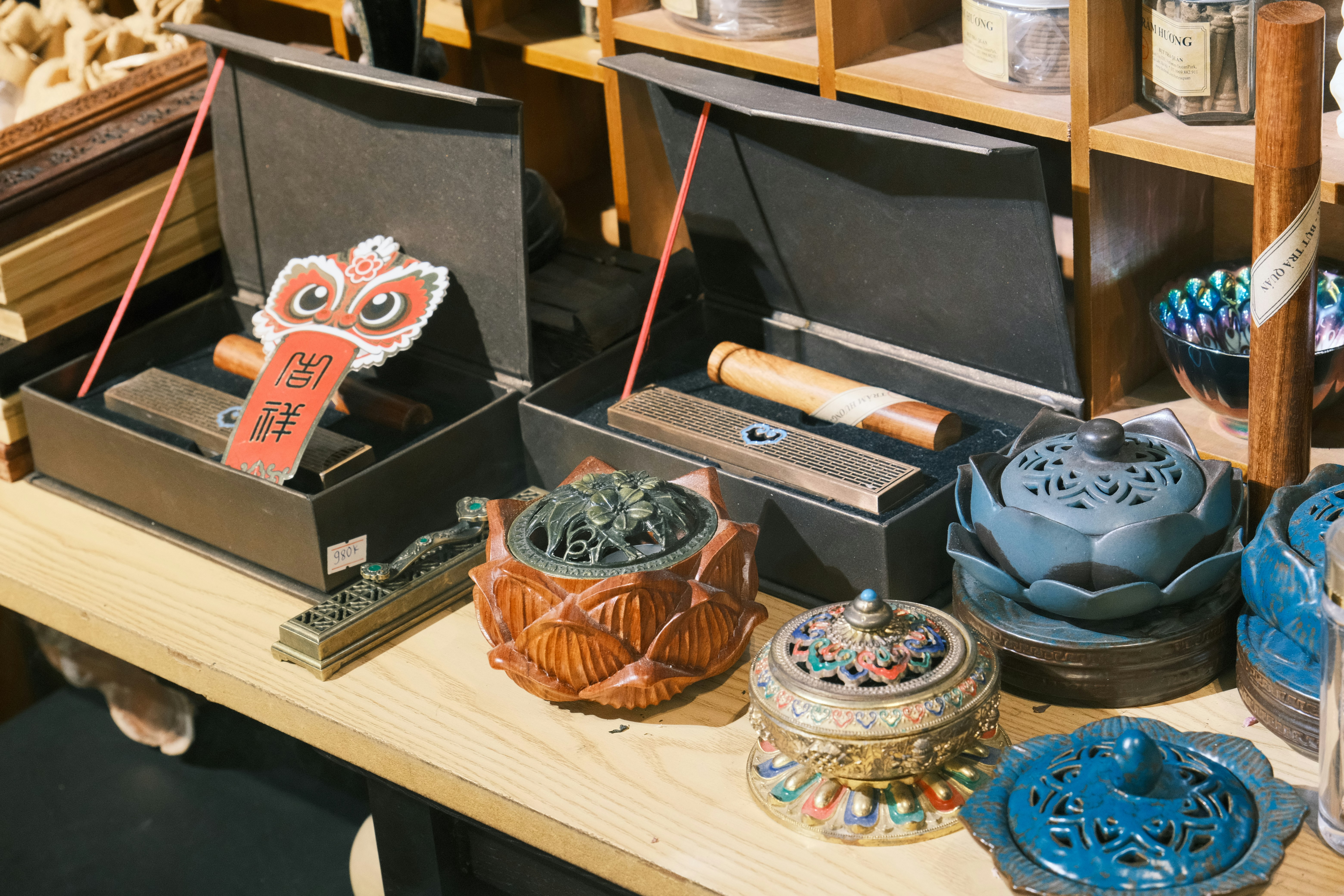 Ornamental Charms and Teaware on a Wooden Shelf