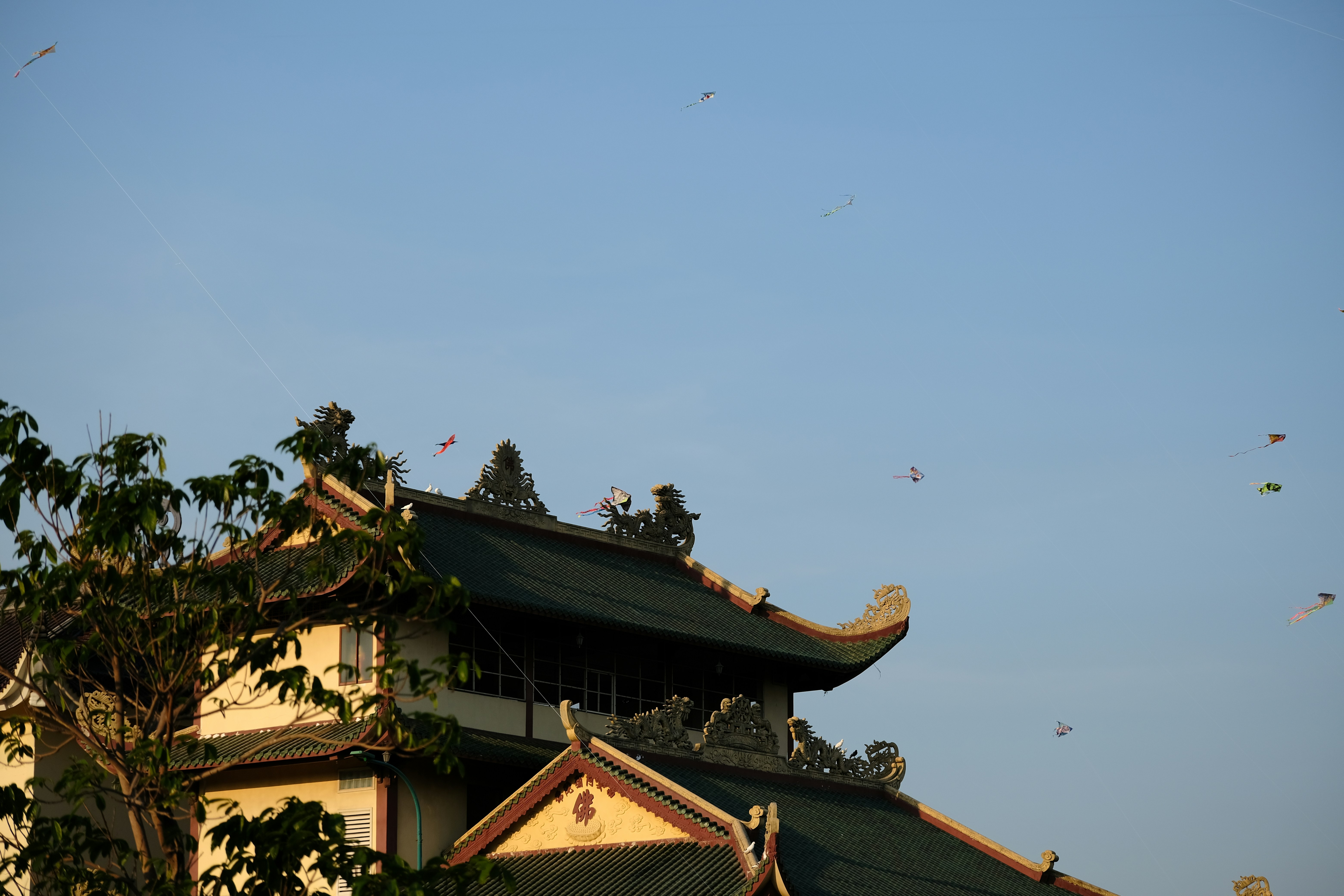 Kites Over a Heritage Roof: Quiet Sky Above Ornate Eaves