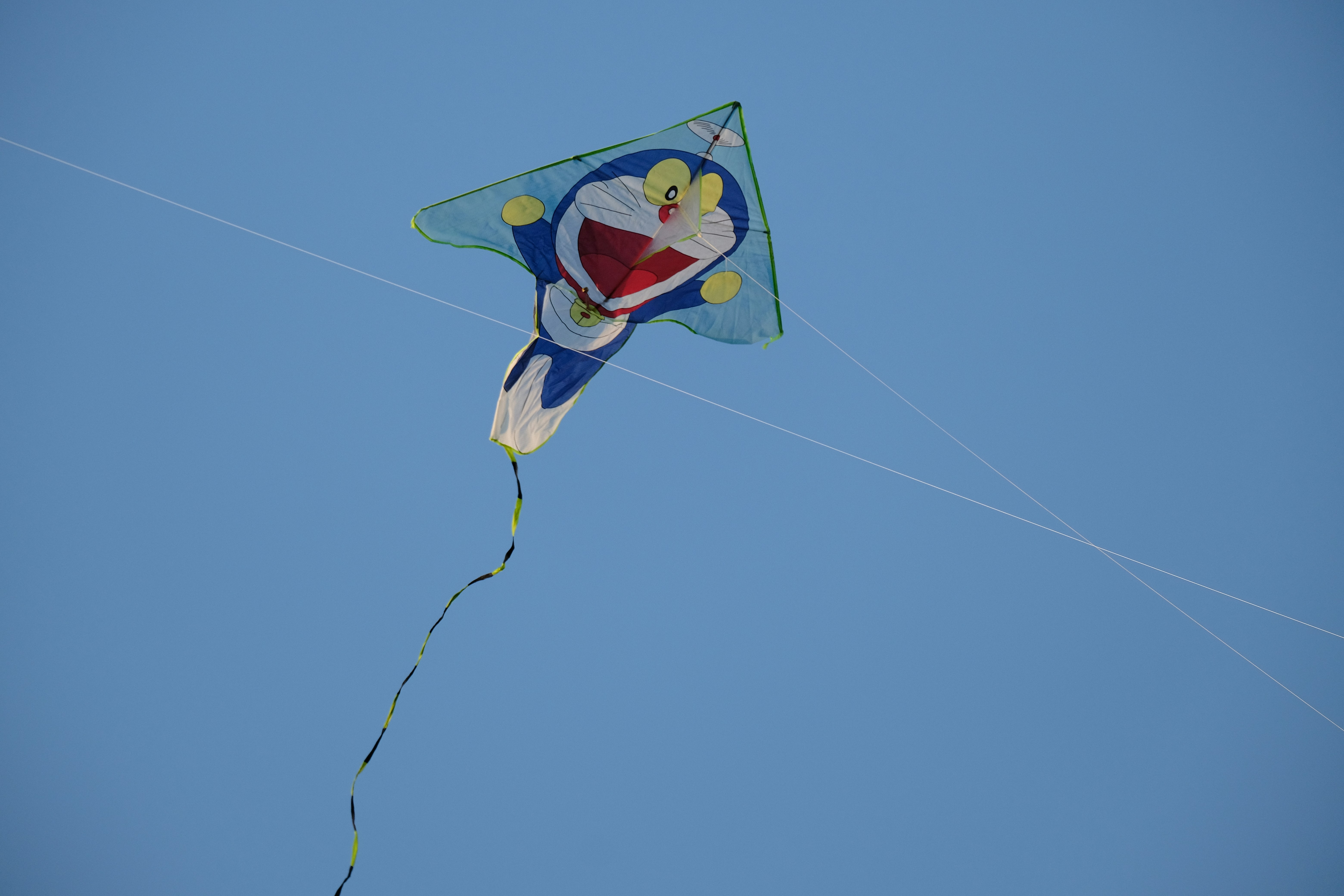 Smiley-Faced Kite Dances Across a Pristine Blue Sky