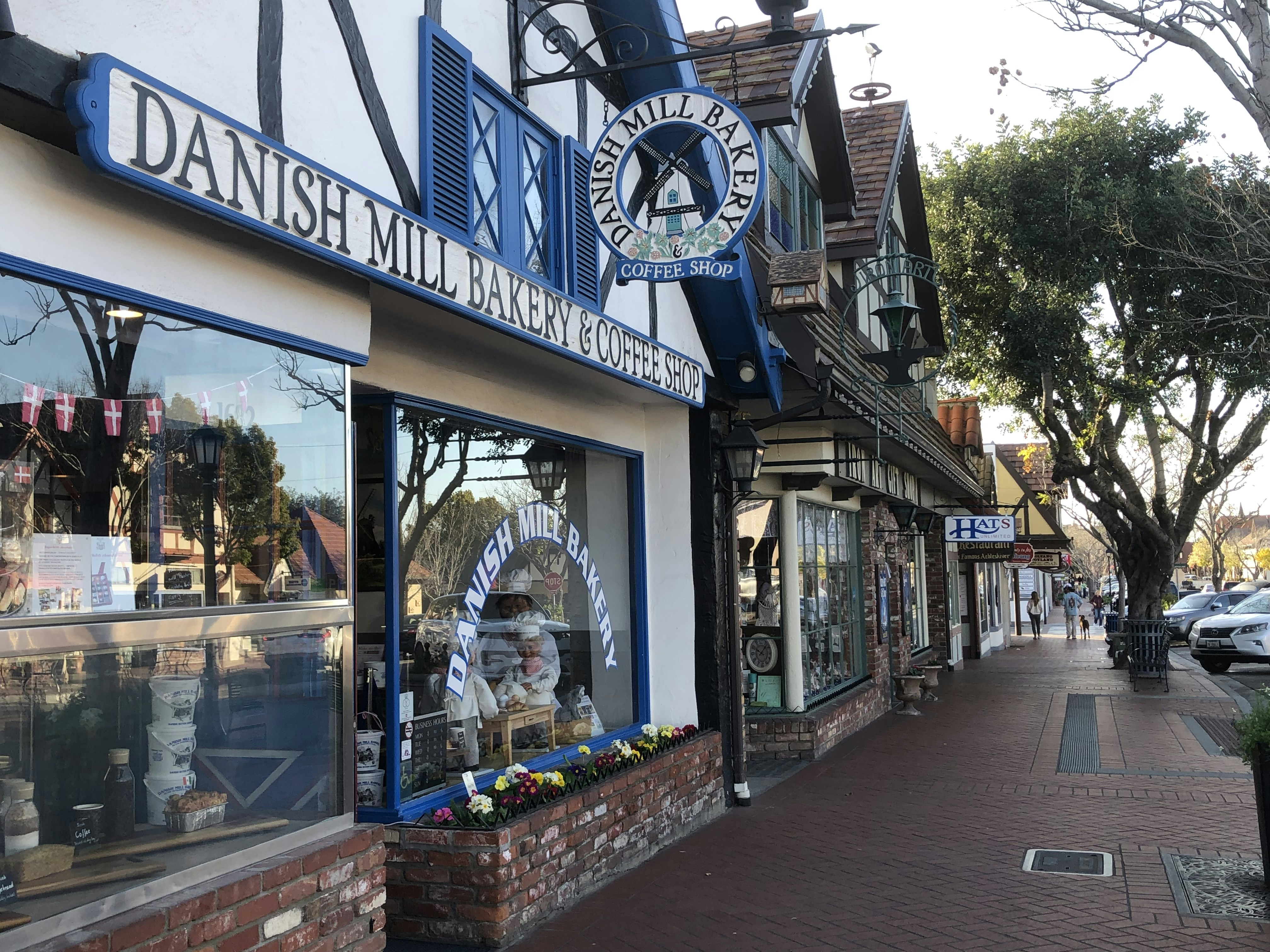 A store front with a clock on the side of it photo – Free Solvang ...