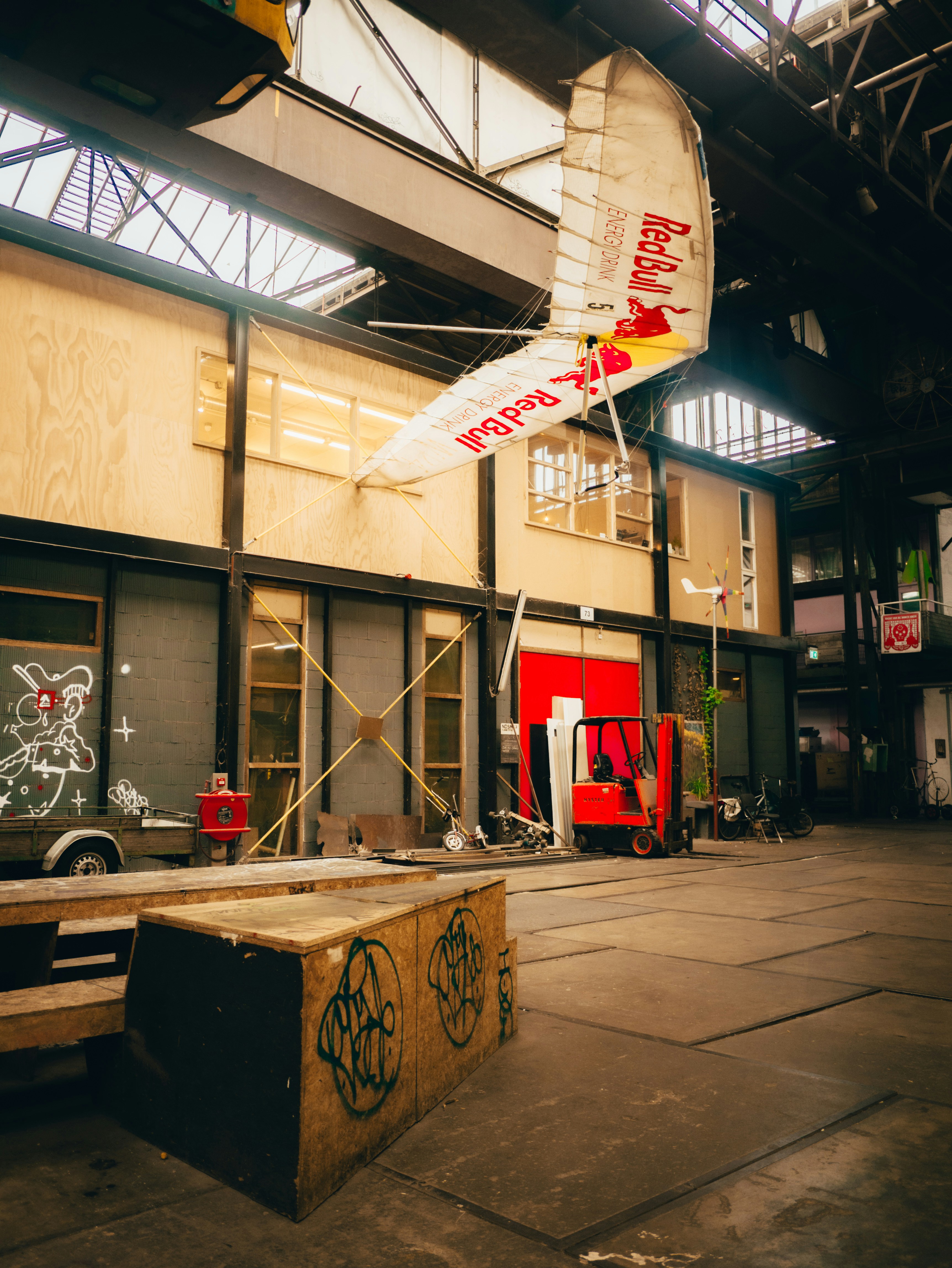 Suspended Red Bull Wing Over an Industrial Workshop