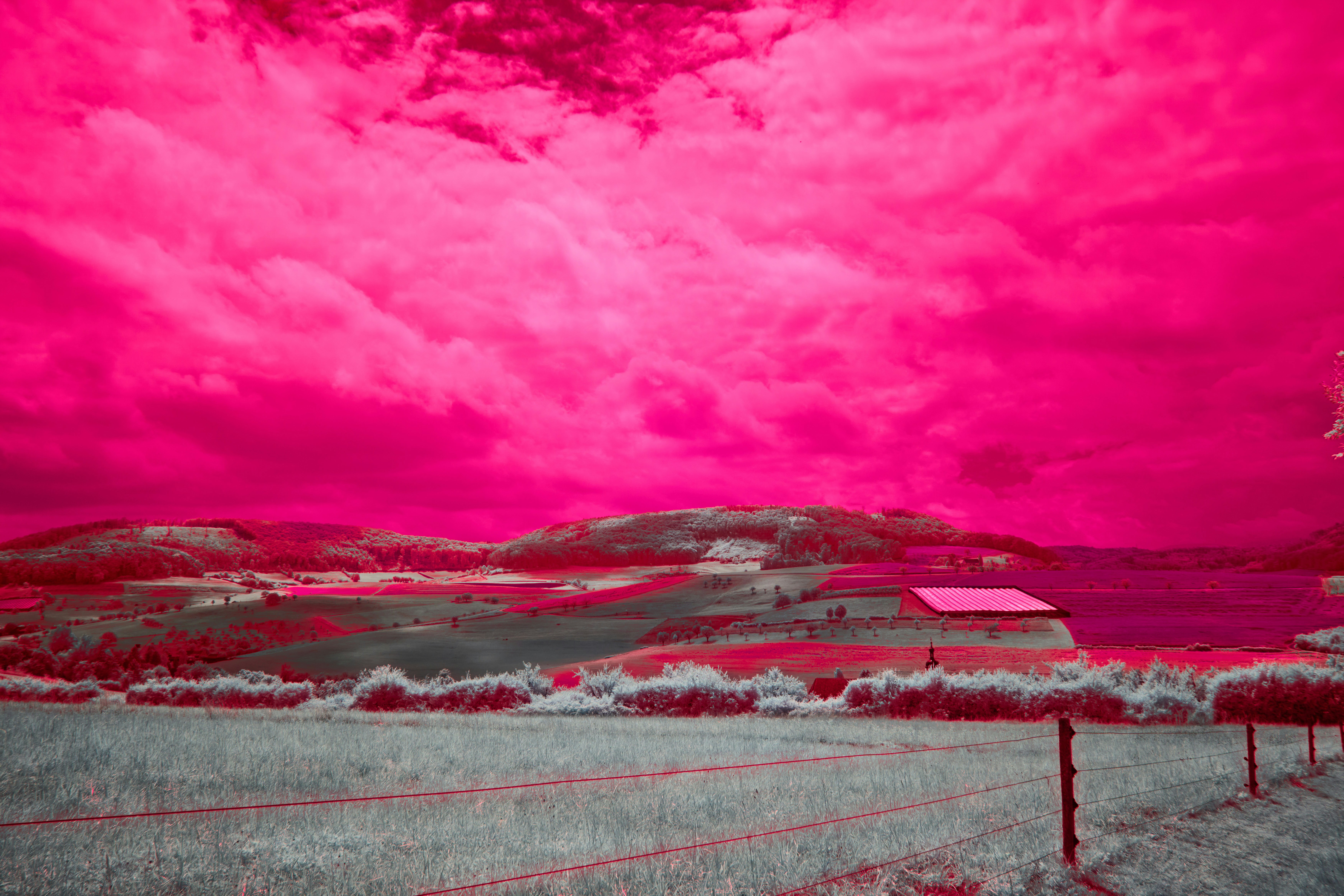 A field with a fence and a red sky photo – Free Pink Image on Unsplash