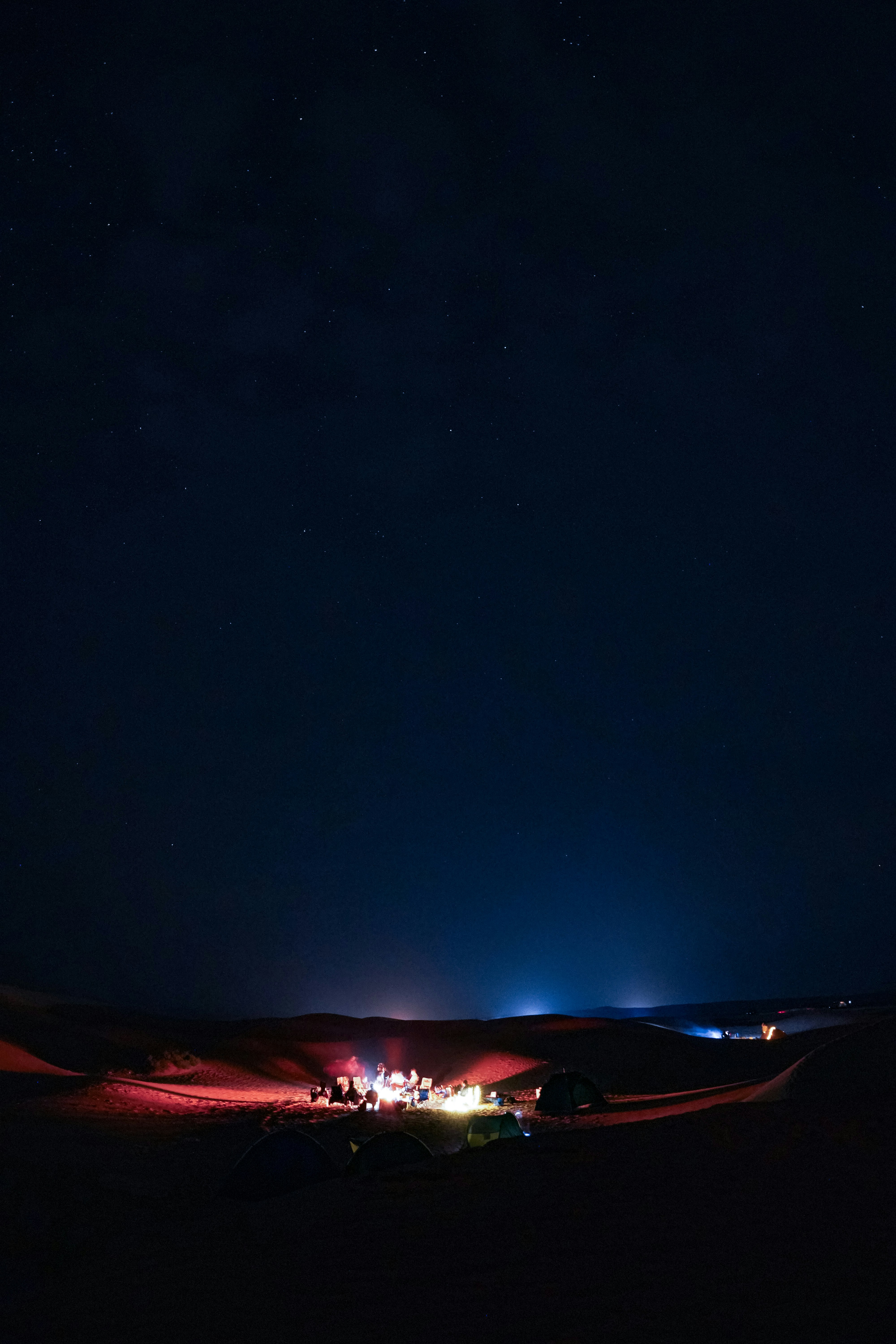 A group of people standing in the desert at night photo – Free Fire Image on Unsplash