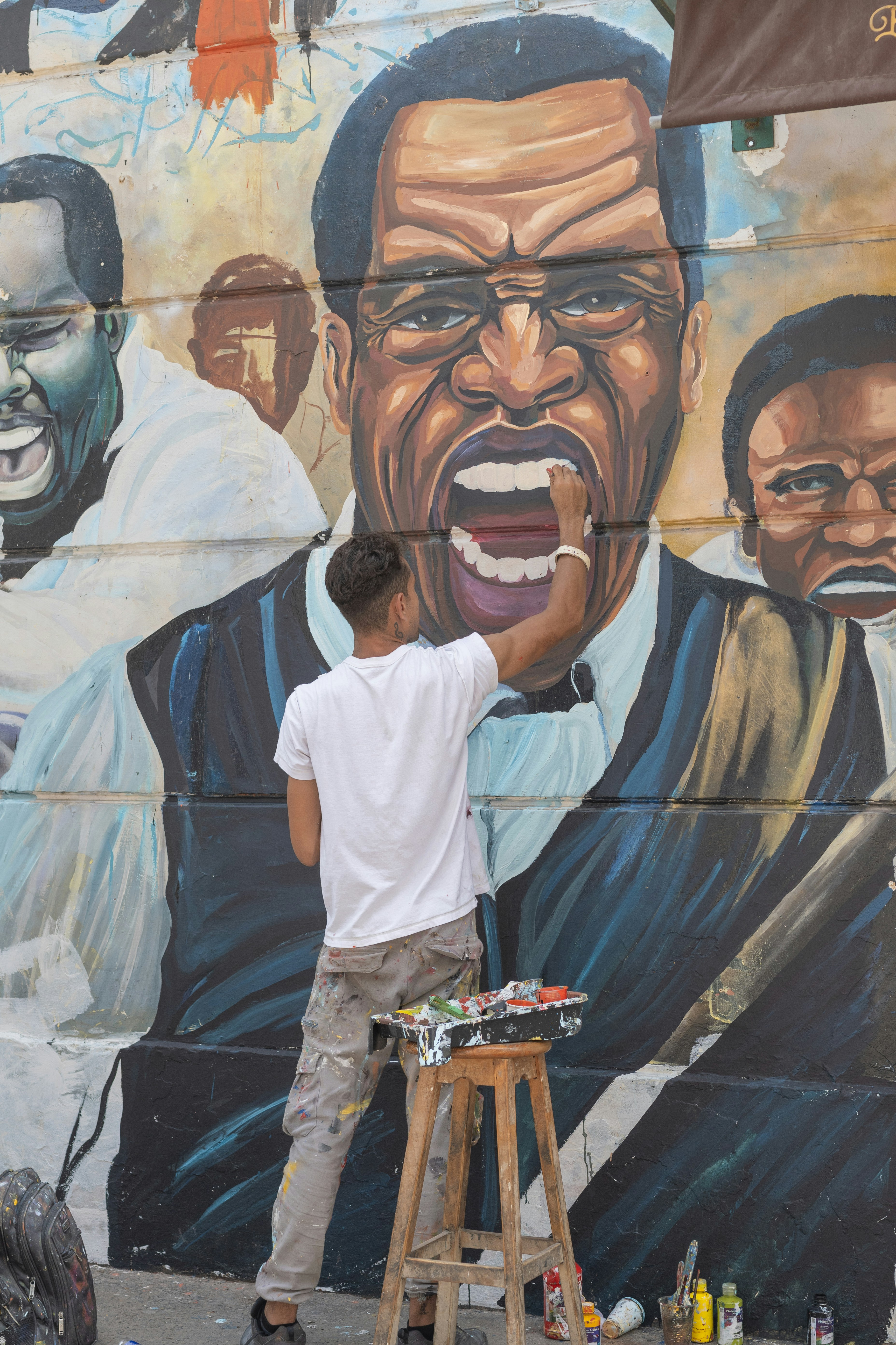 A man is painting a mural on a wall photo – Free Cartagena Image on ...
